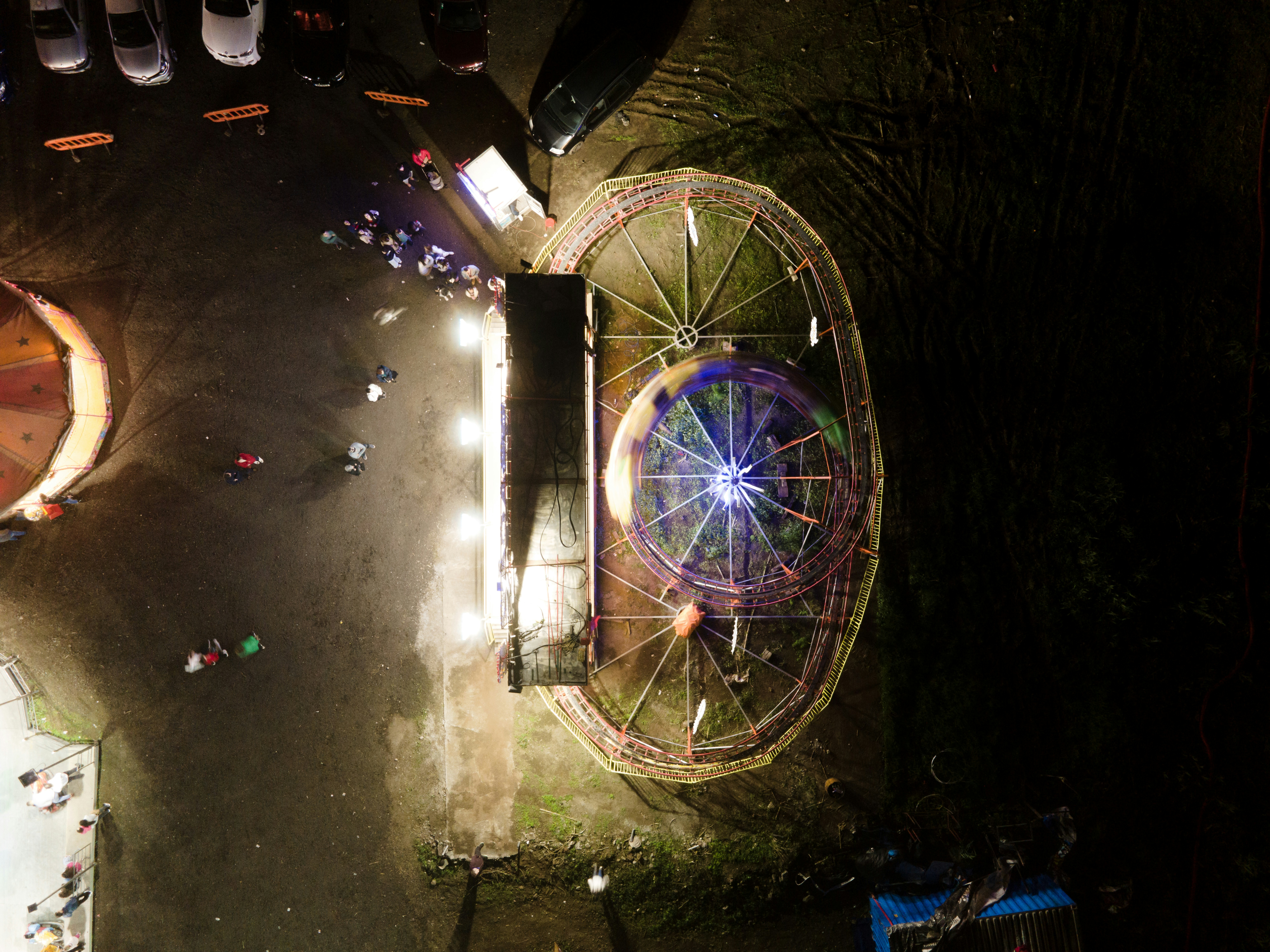 Neon-Spoked Rotunda: Night Drone Sweep Over a Circular Carousel Pavilion