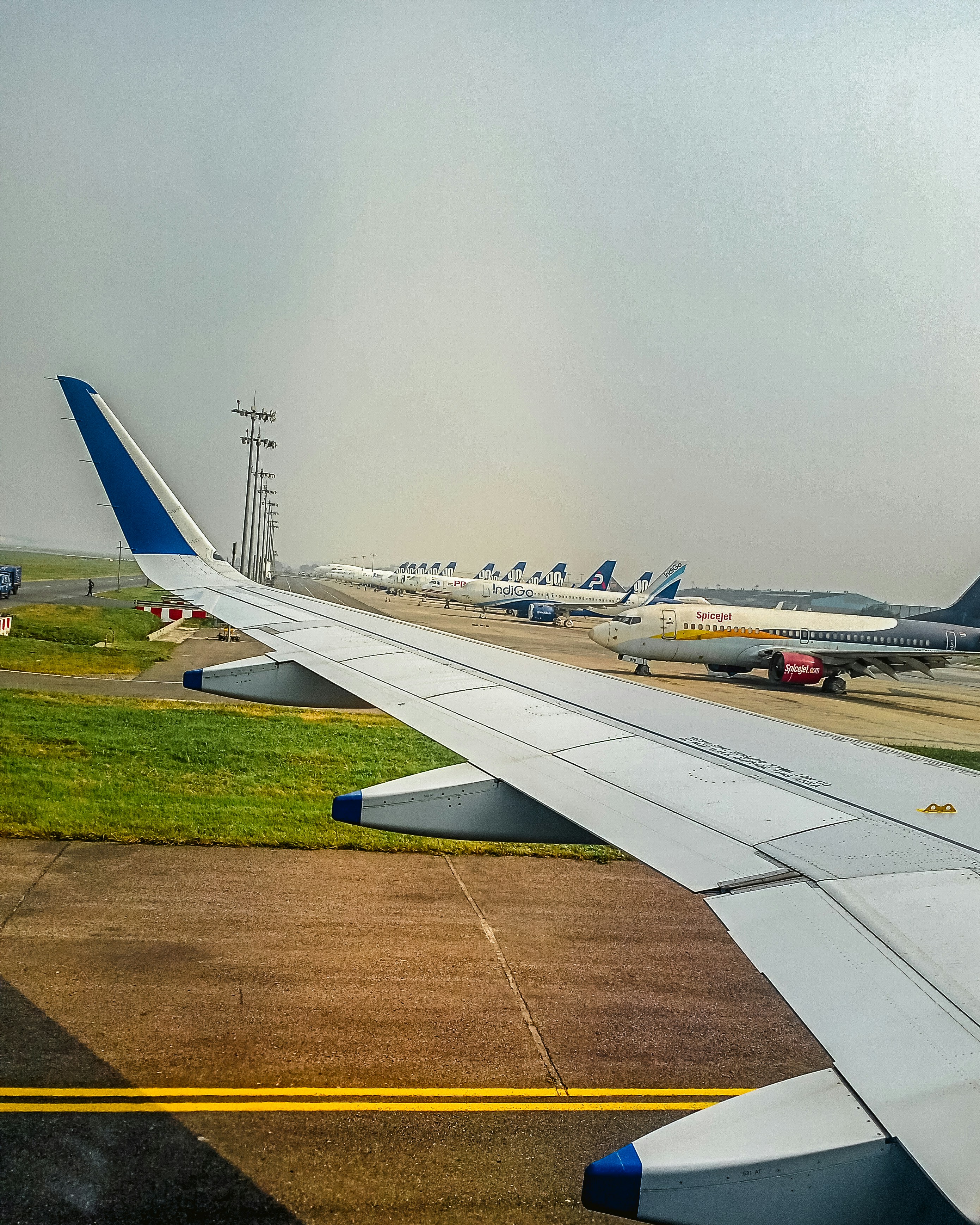 A row of airplanes parked on a runway photo – Free Igi airport terminal ...