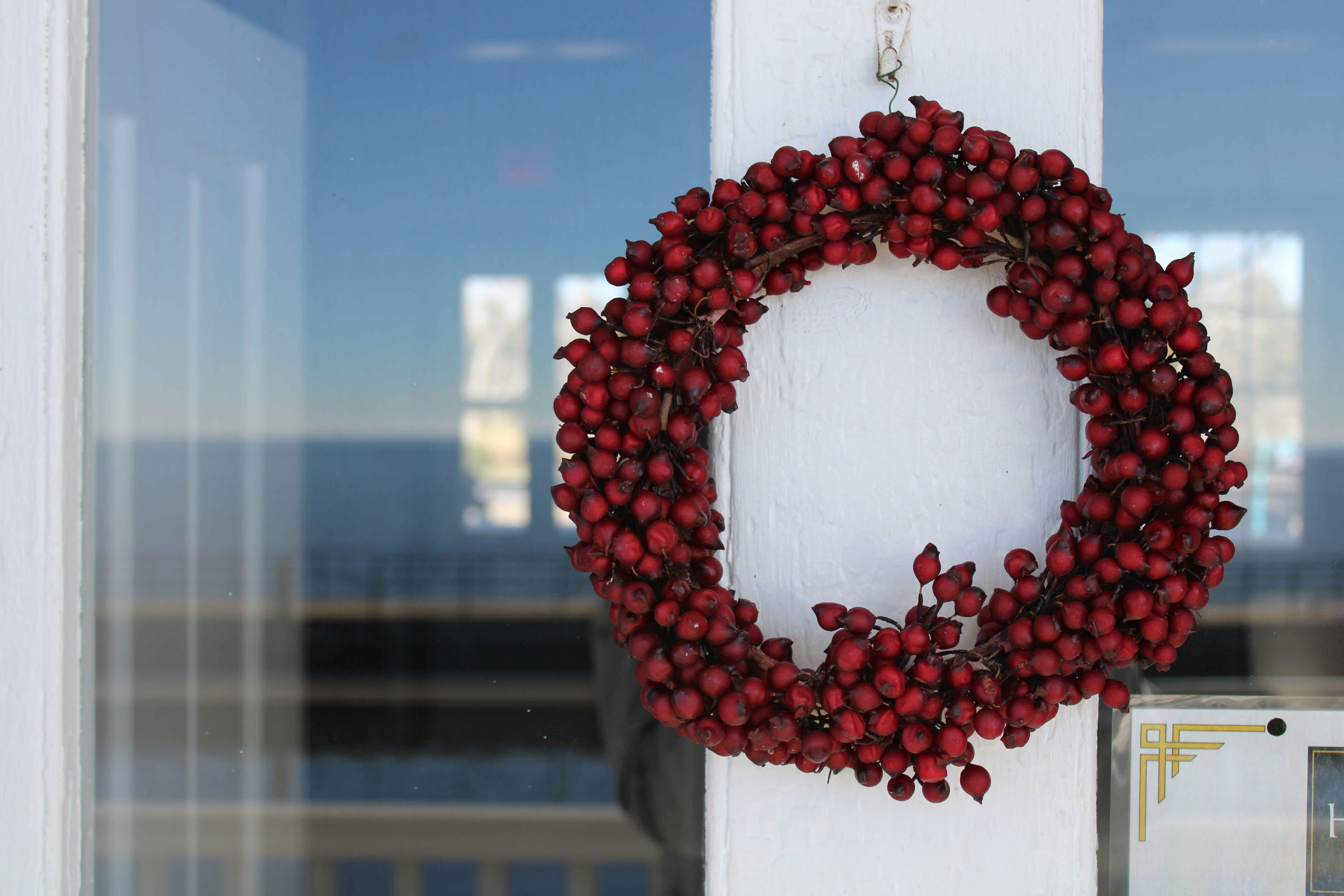 Crimson Wreath Framed by Coastal Glass