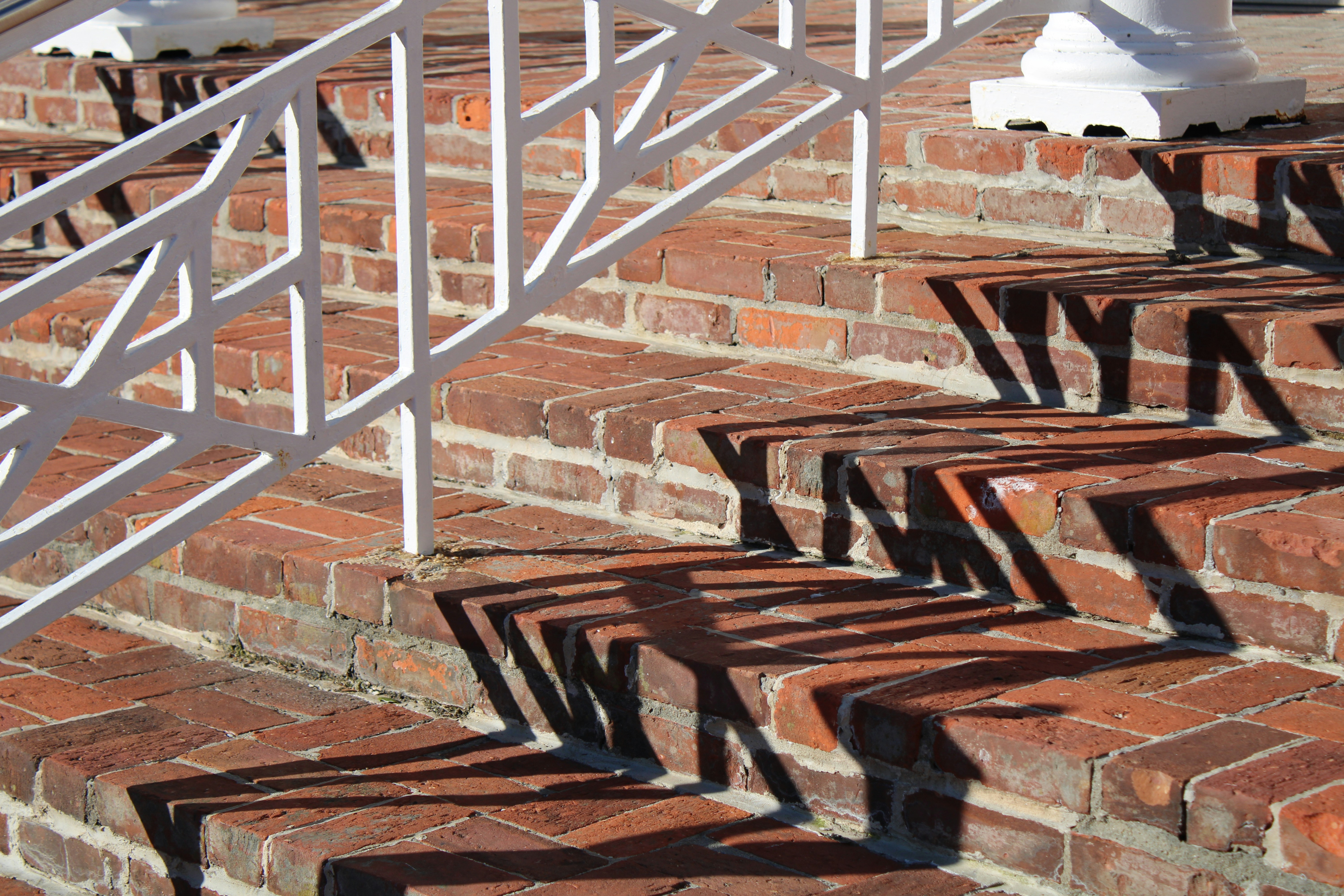A white fire hydrant sitting on top of a set of stairs photo – Free ...