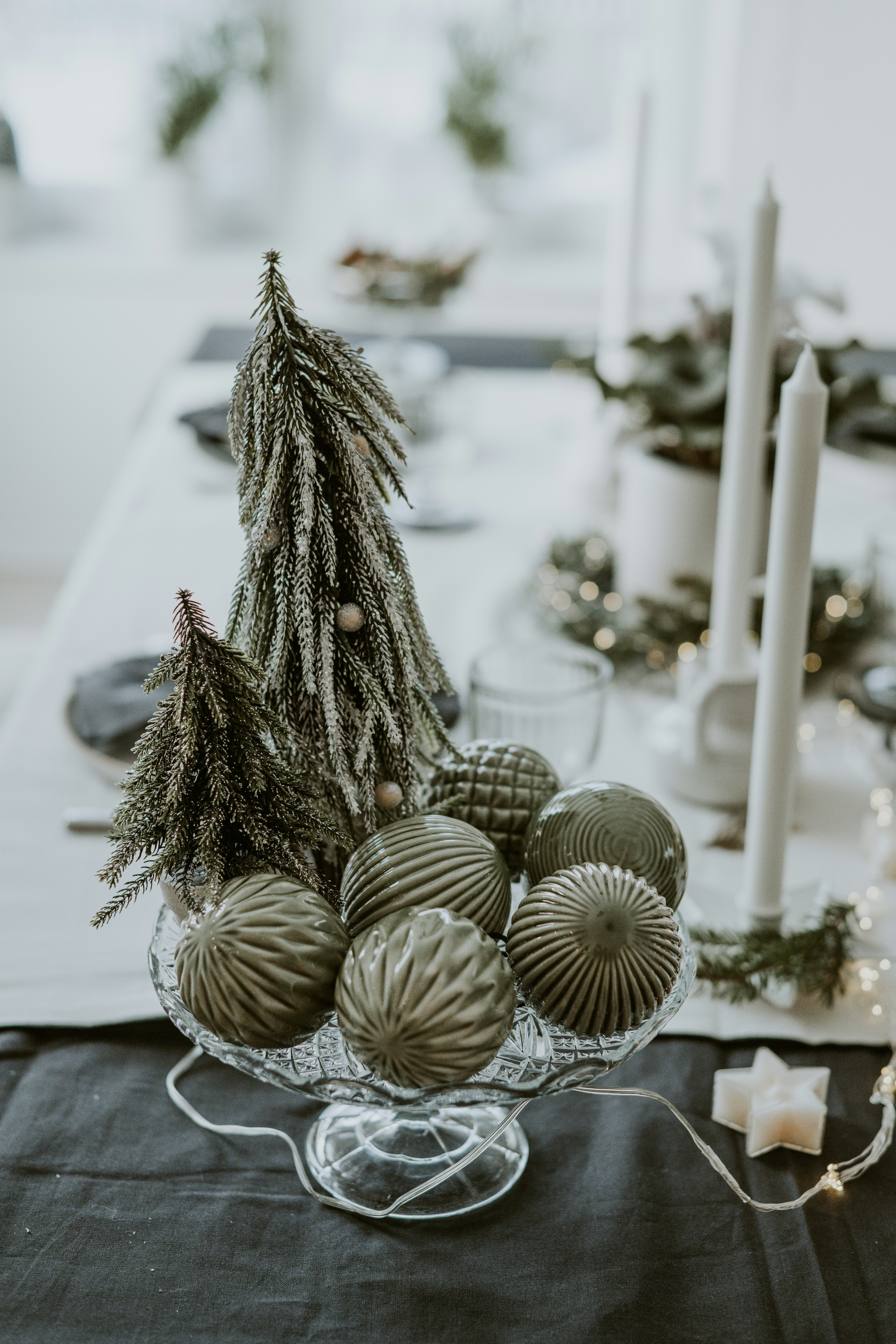 Frosted centerpiece: glass pedestal with frosted ornaments and miniature pine tree