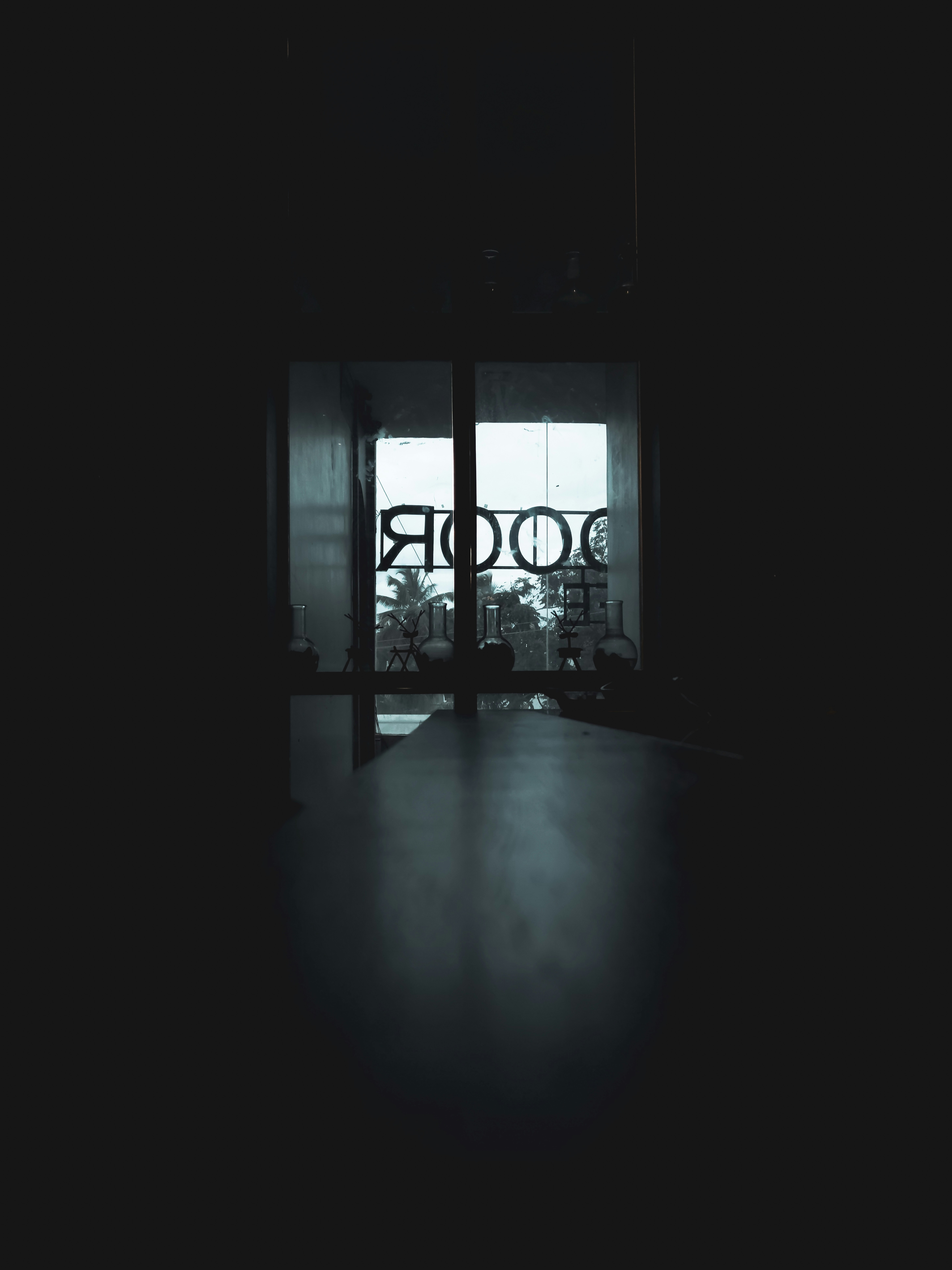 Windowed Echoes: A Dim Café Through a Glass Door