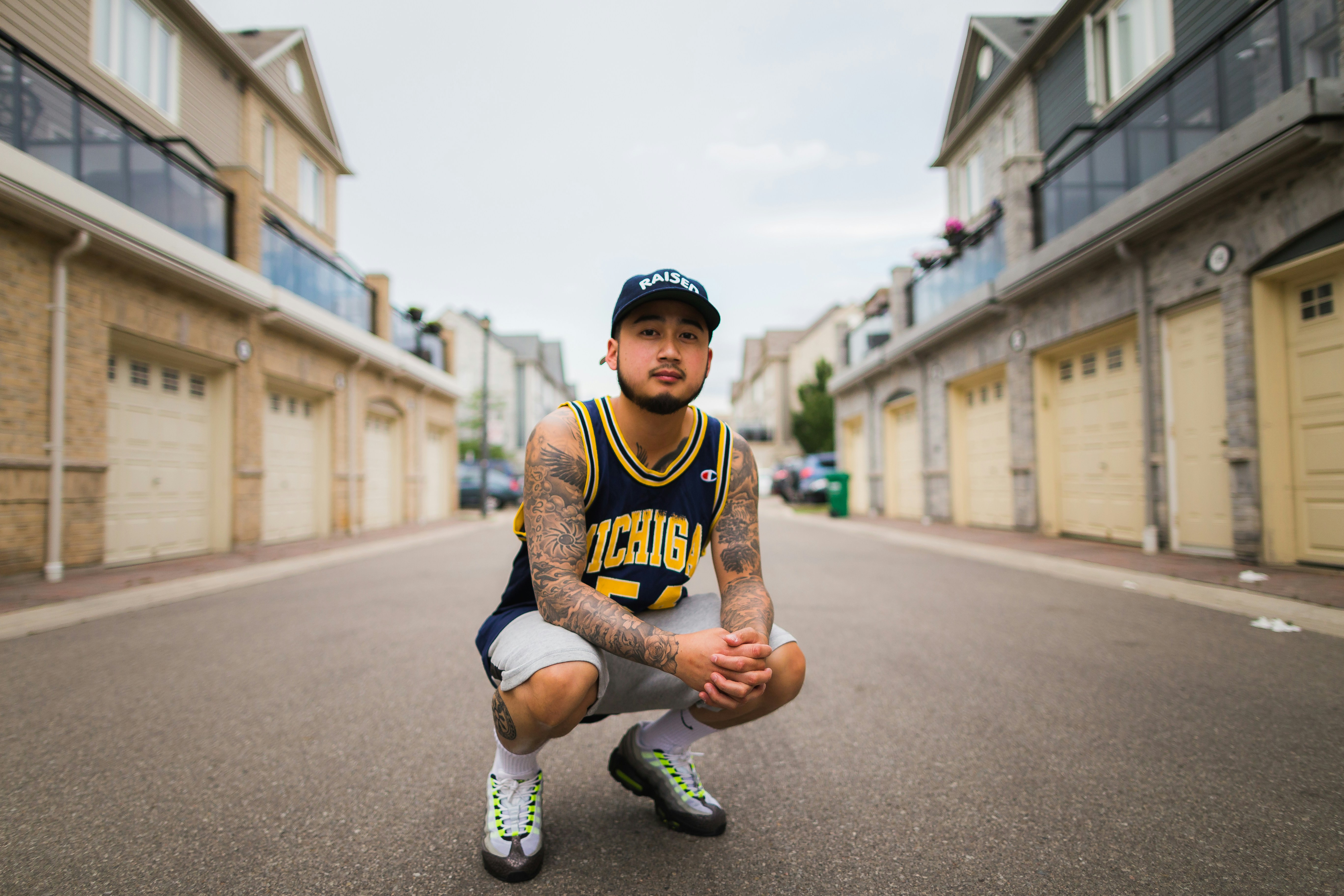 A basketball player squatting down in the middle of a street photo ...