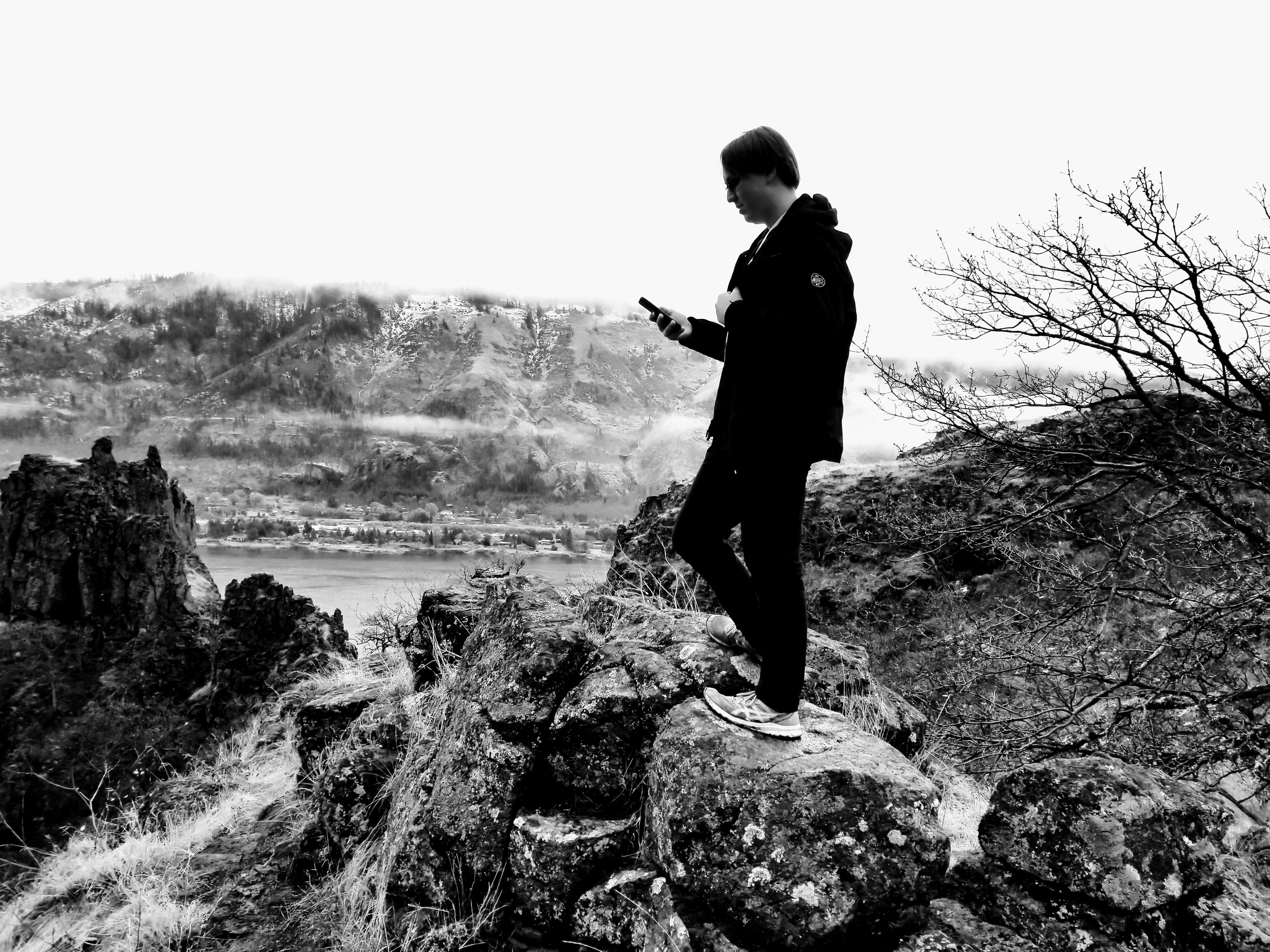 Teen standing on a rock in the columbia gorge. Model: Samuel Robbins.