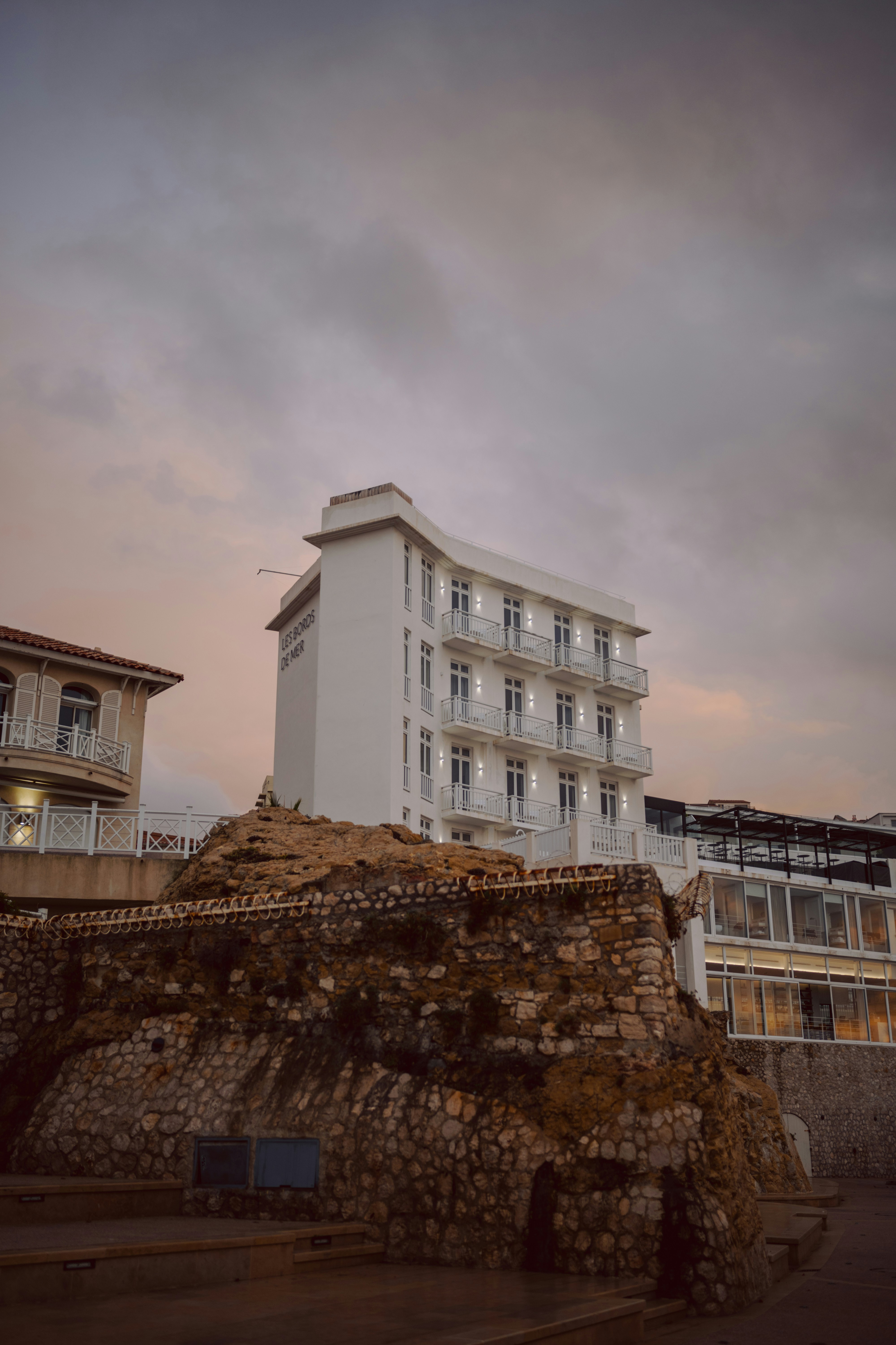 Seaside Terrace Overlook: A White Hotel Rising Above Ancient Stone Fortifications
