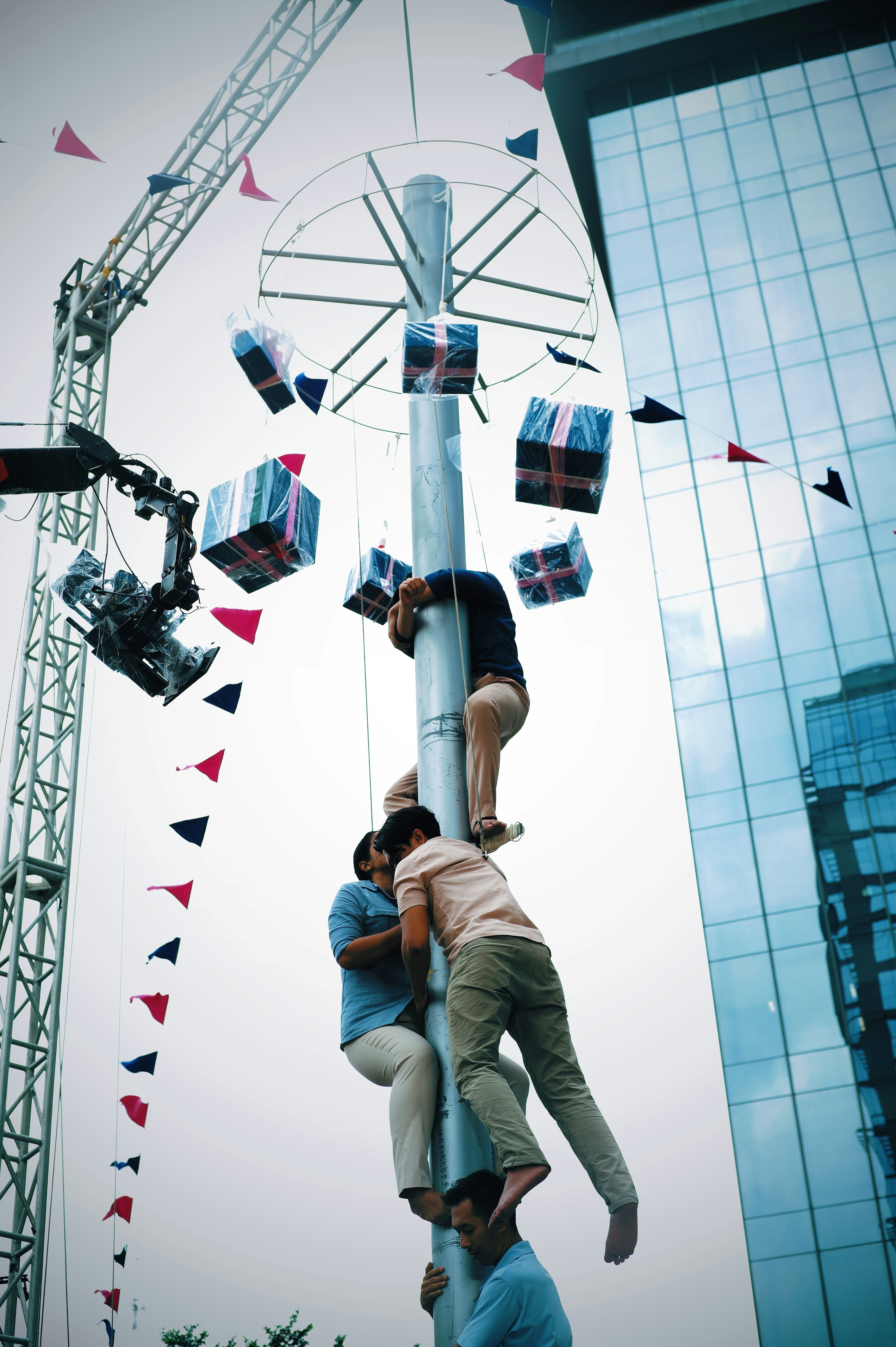 A group of people hanging upside down on a pole photo – Free Image on ...