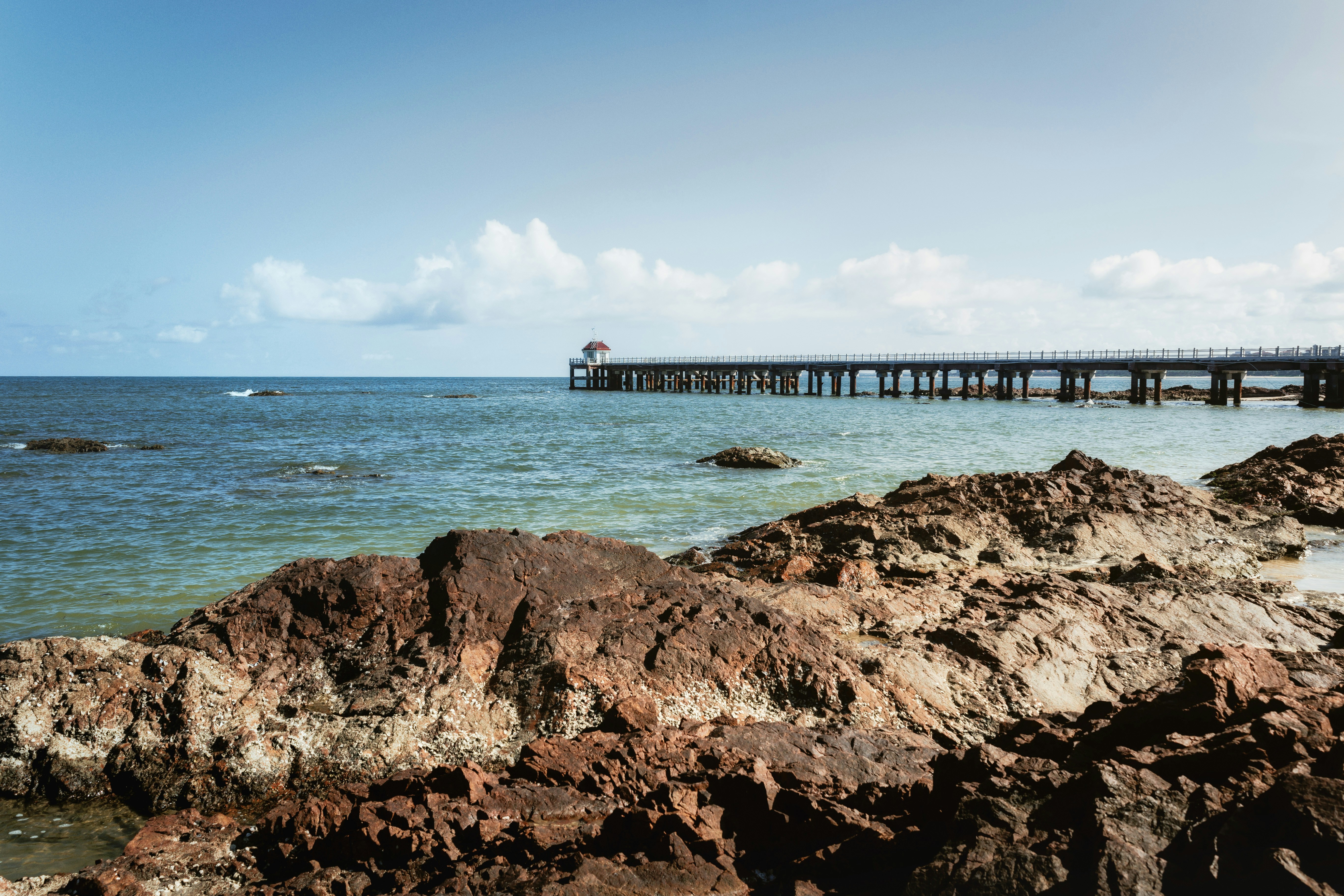 Rugged Coastline and Pier Quietly Reaching into the Sea