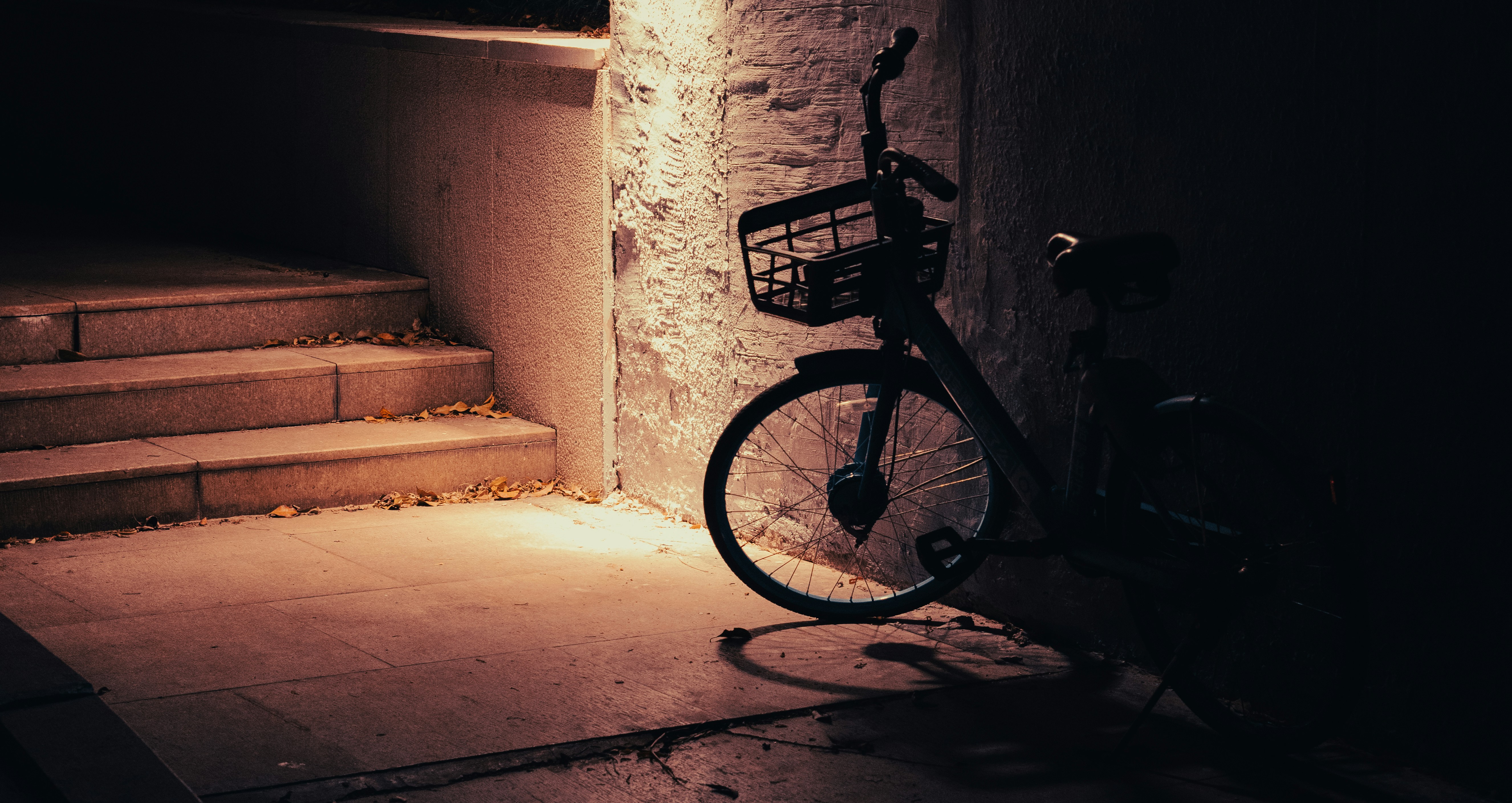 Amber Halo: A Lone Bicycle Waits in the Shadowed Stairwell