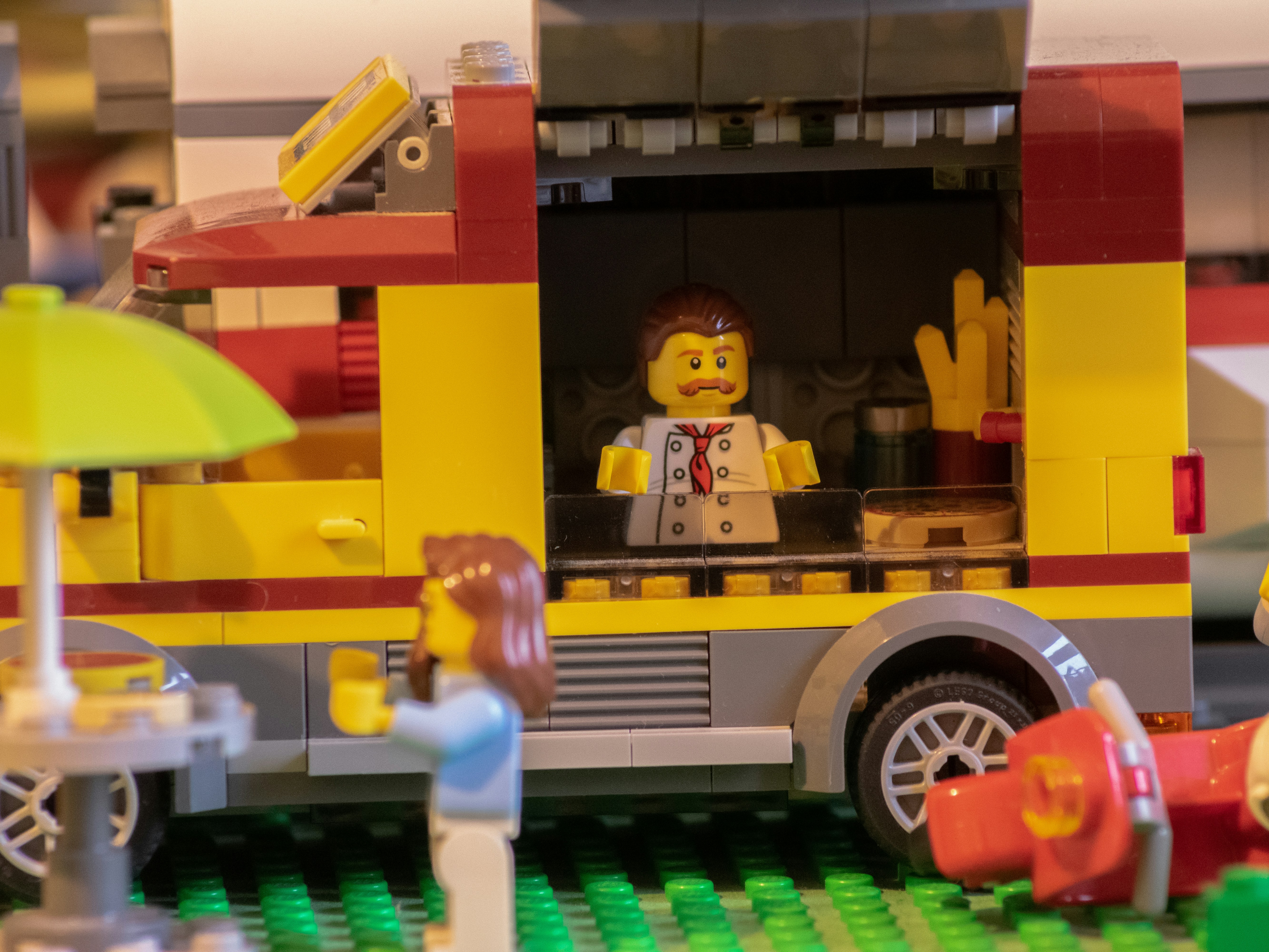 LEGO yellow pizza man in his yellow pizza van