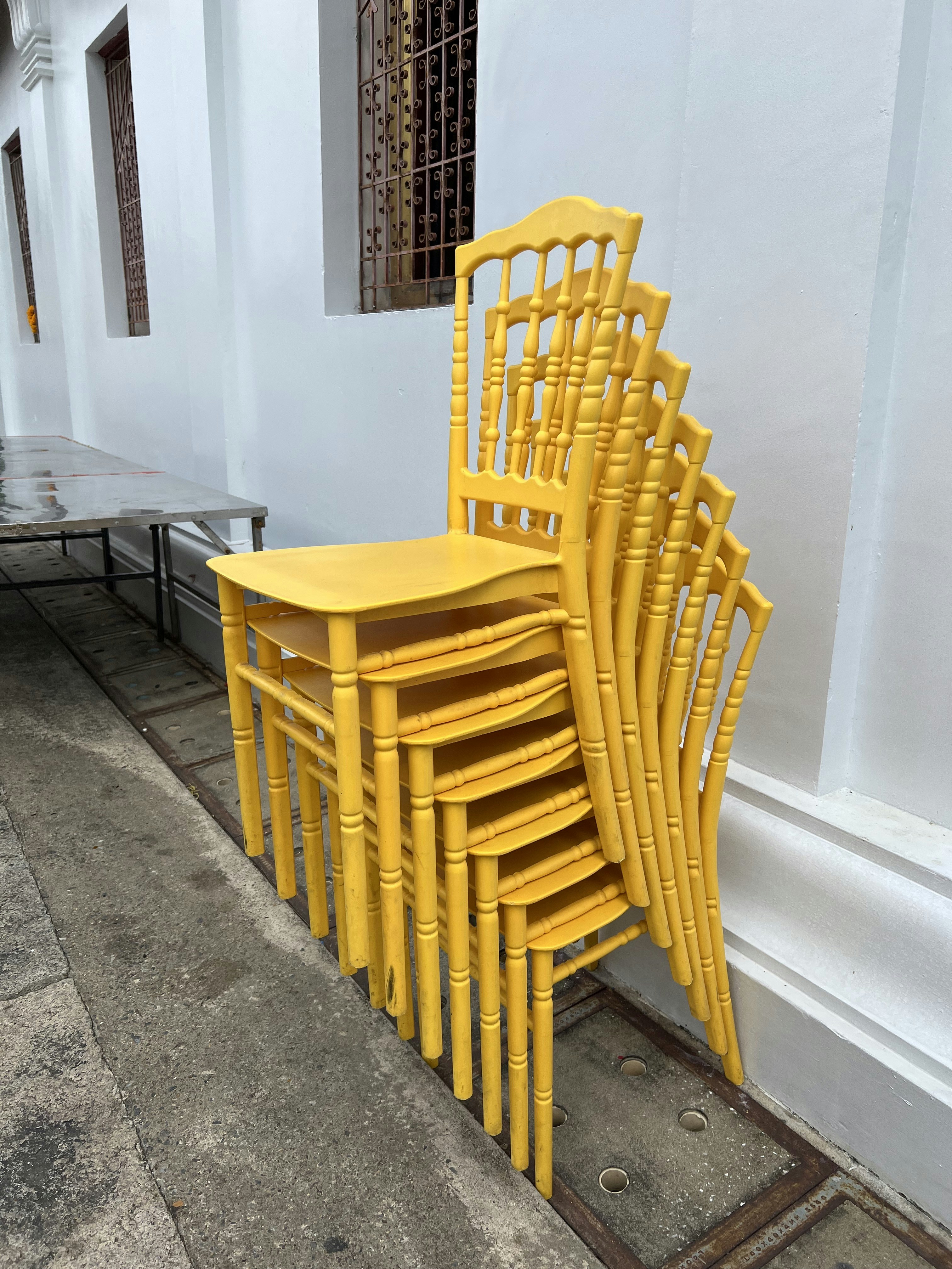 a stack of yellow chairs sitting next to each other