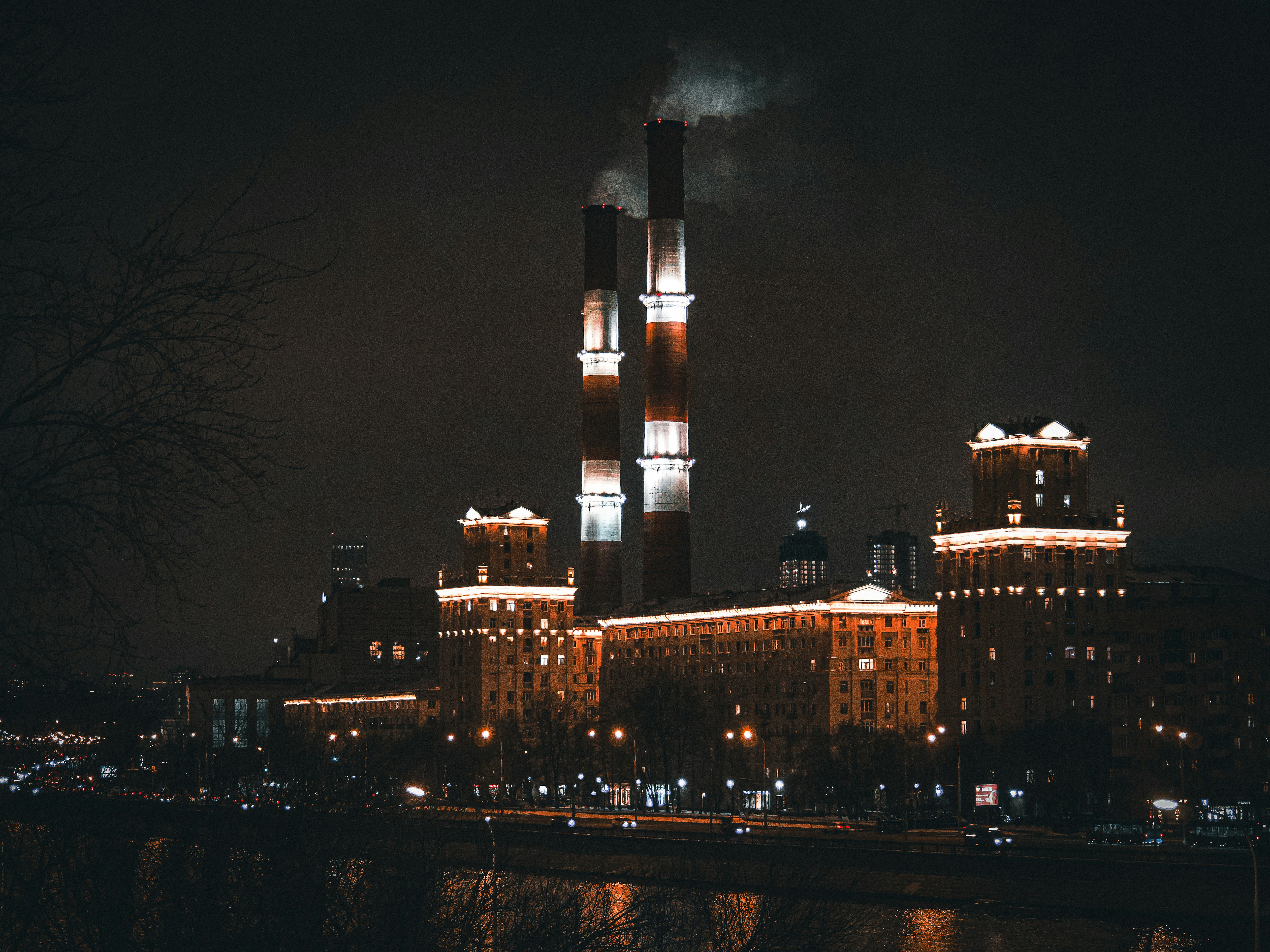 A large factory building with smoke coming out of it's stacks photo ...