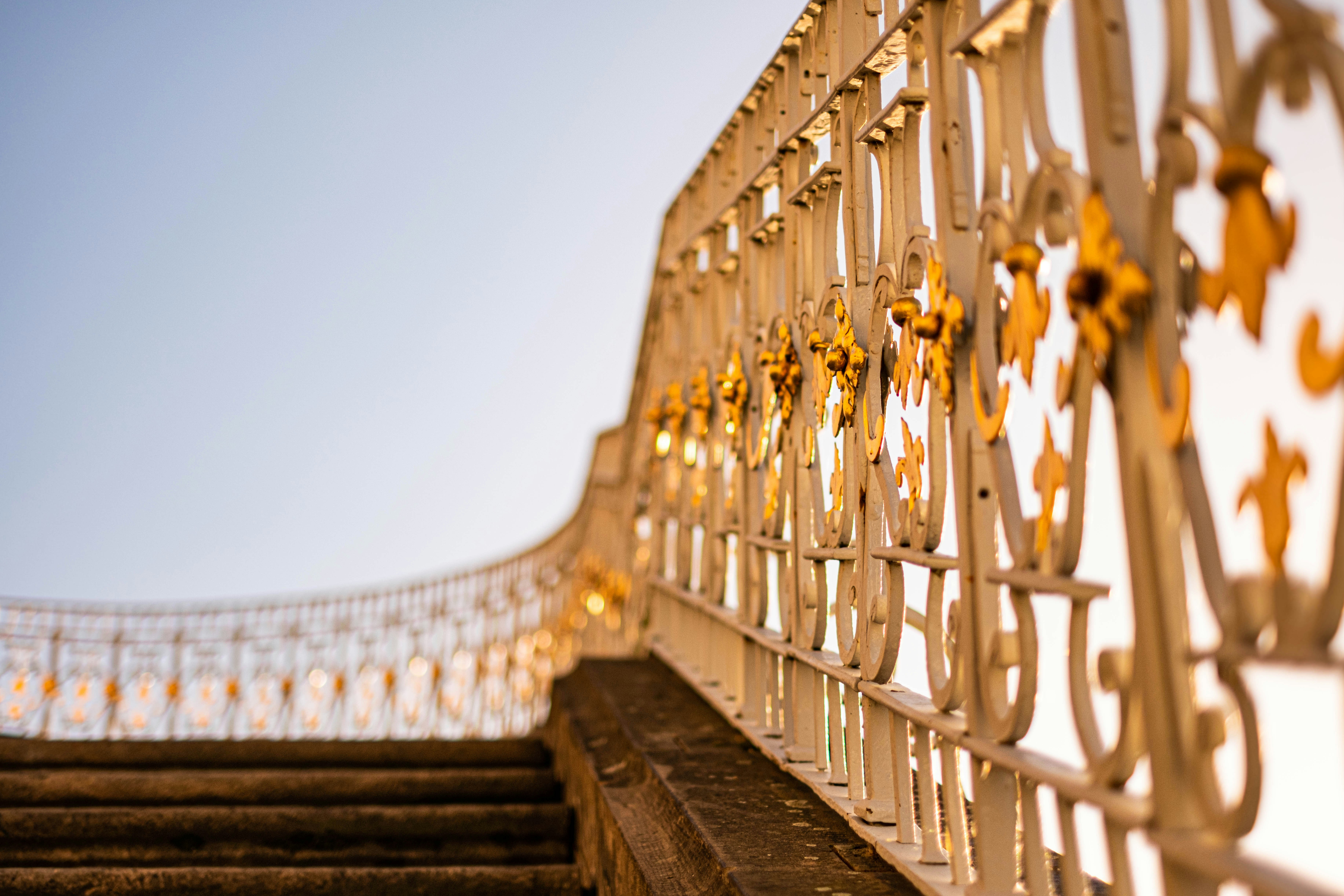 Sunlit Lattice Rail: Perspective Along a Golden Hour Bridge