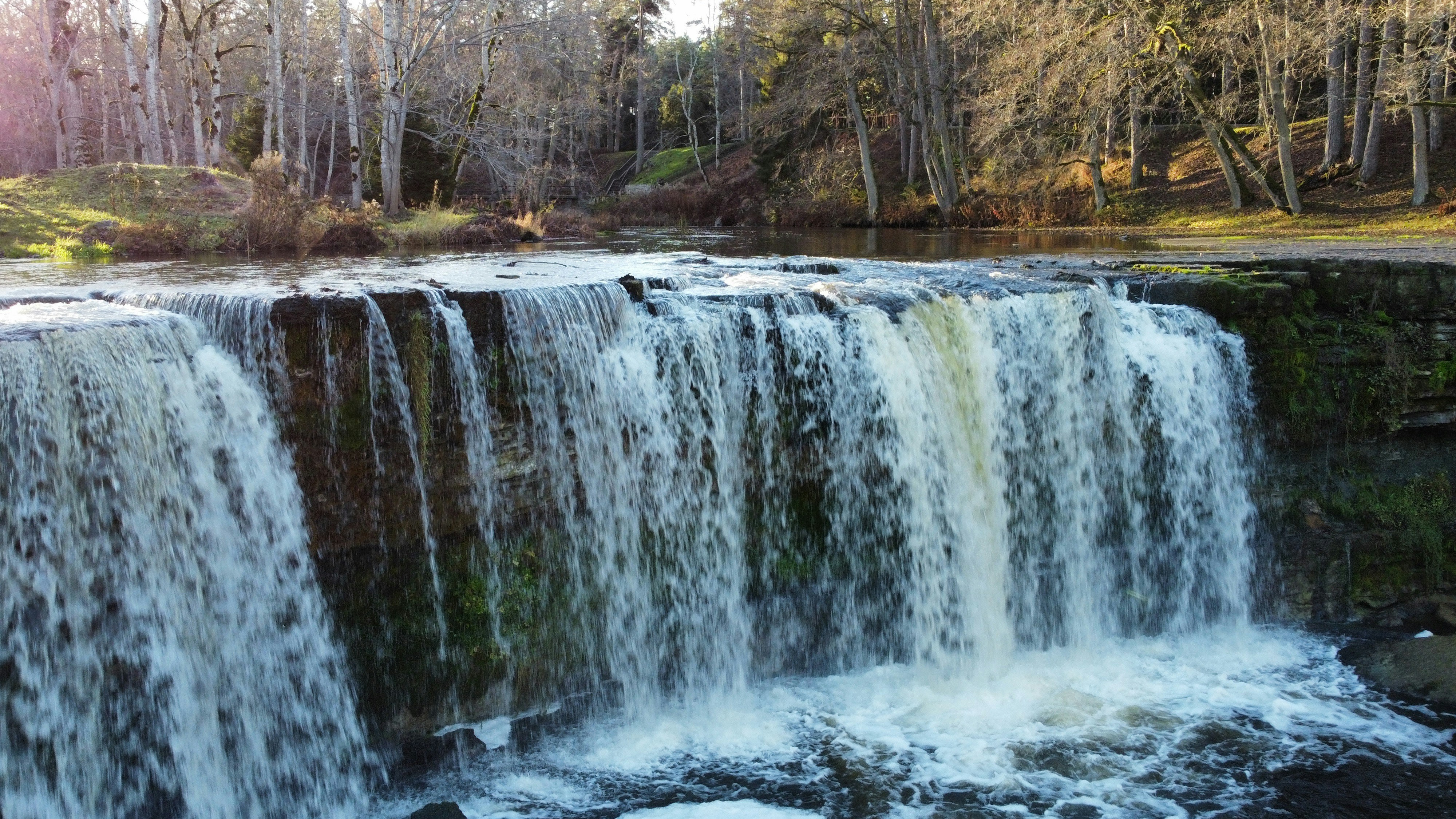 A large waterfall in the middle of a forest photo – Free Land Image on ...