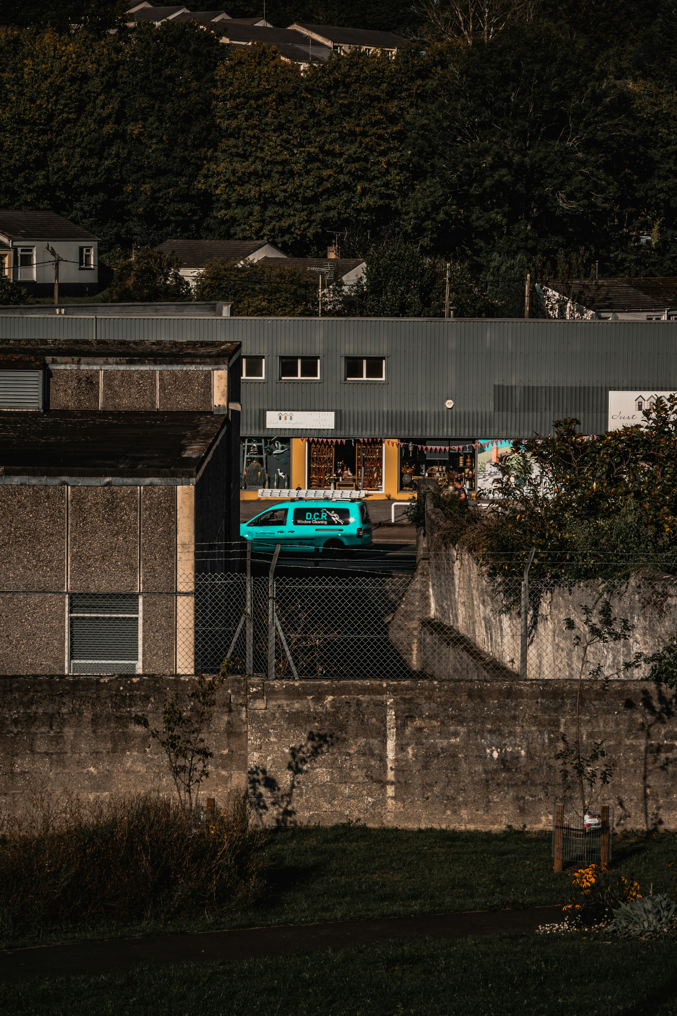 A blue bus parked in front of a building photo – Free Penryn Image on ...