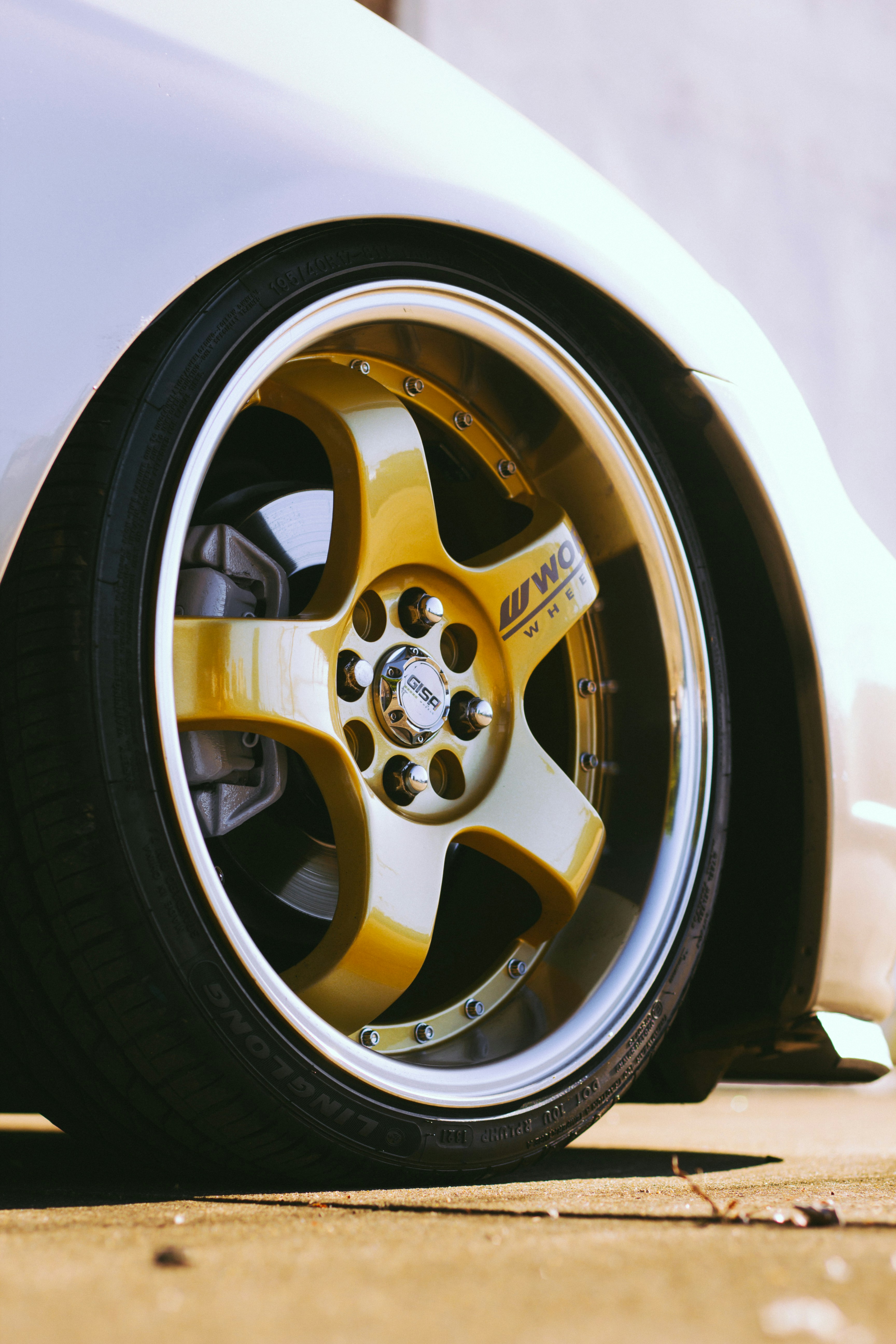 A close up of a white car with yellow rims photo – Free Brazil Image on ...