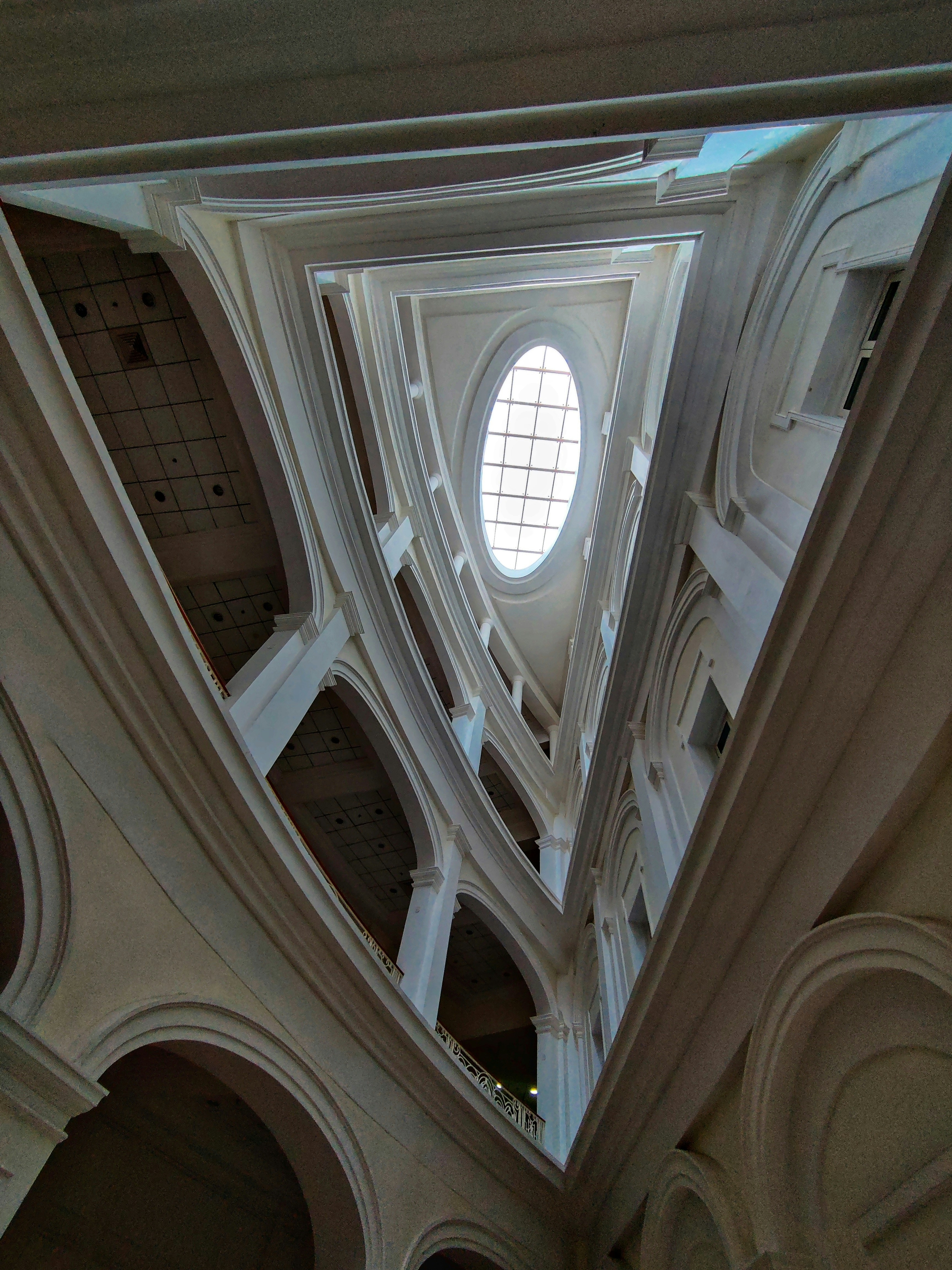 The ceiling of a building with a circular window photo – Free Building ...