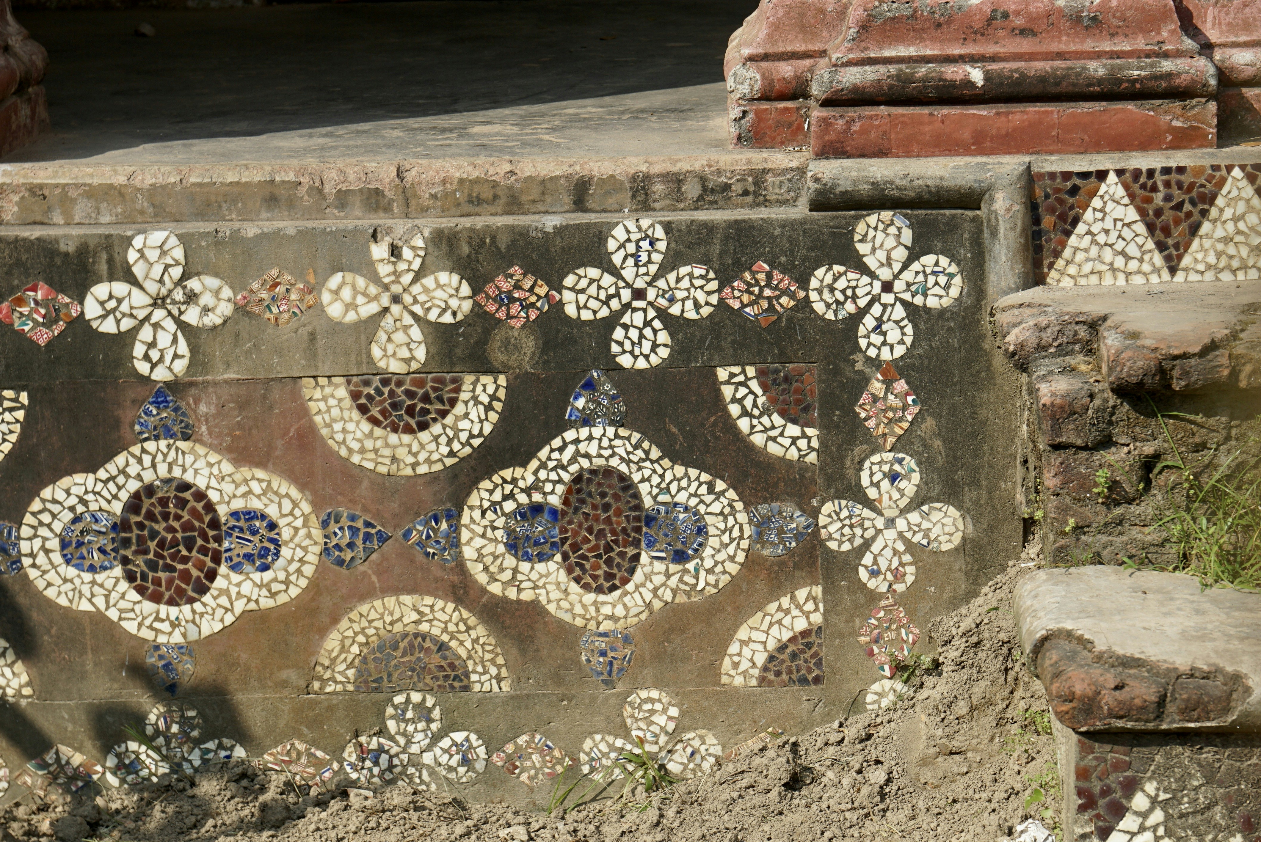 Circular Mosaic Bloom on a Weathered Terrace Wall