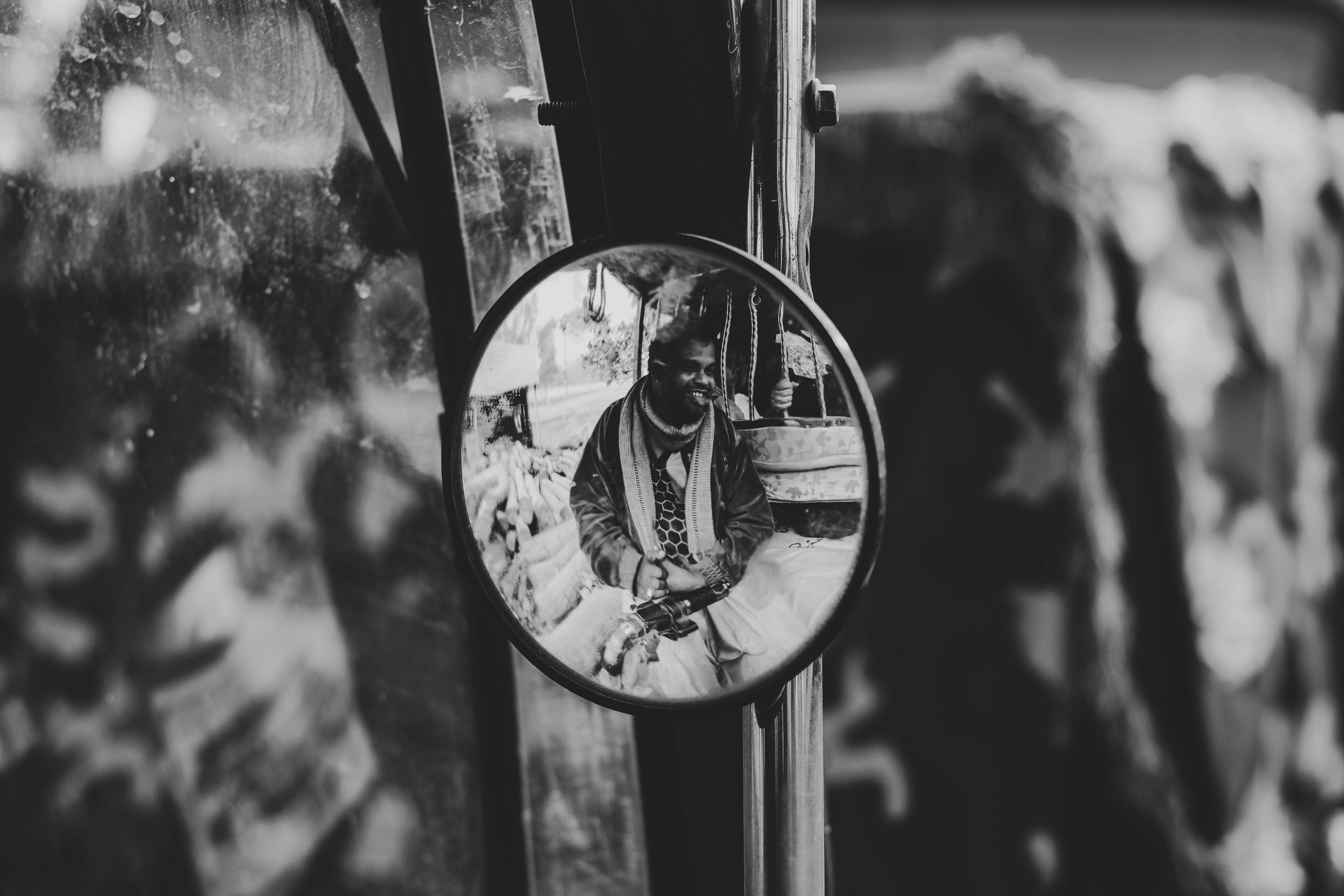 Circle of Quiet: A Passenger Framed in a Bus Mirror