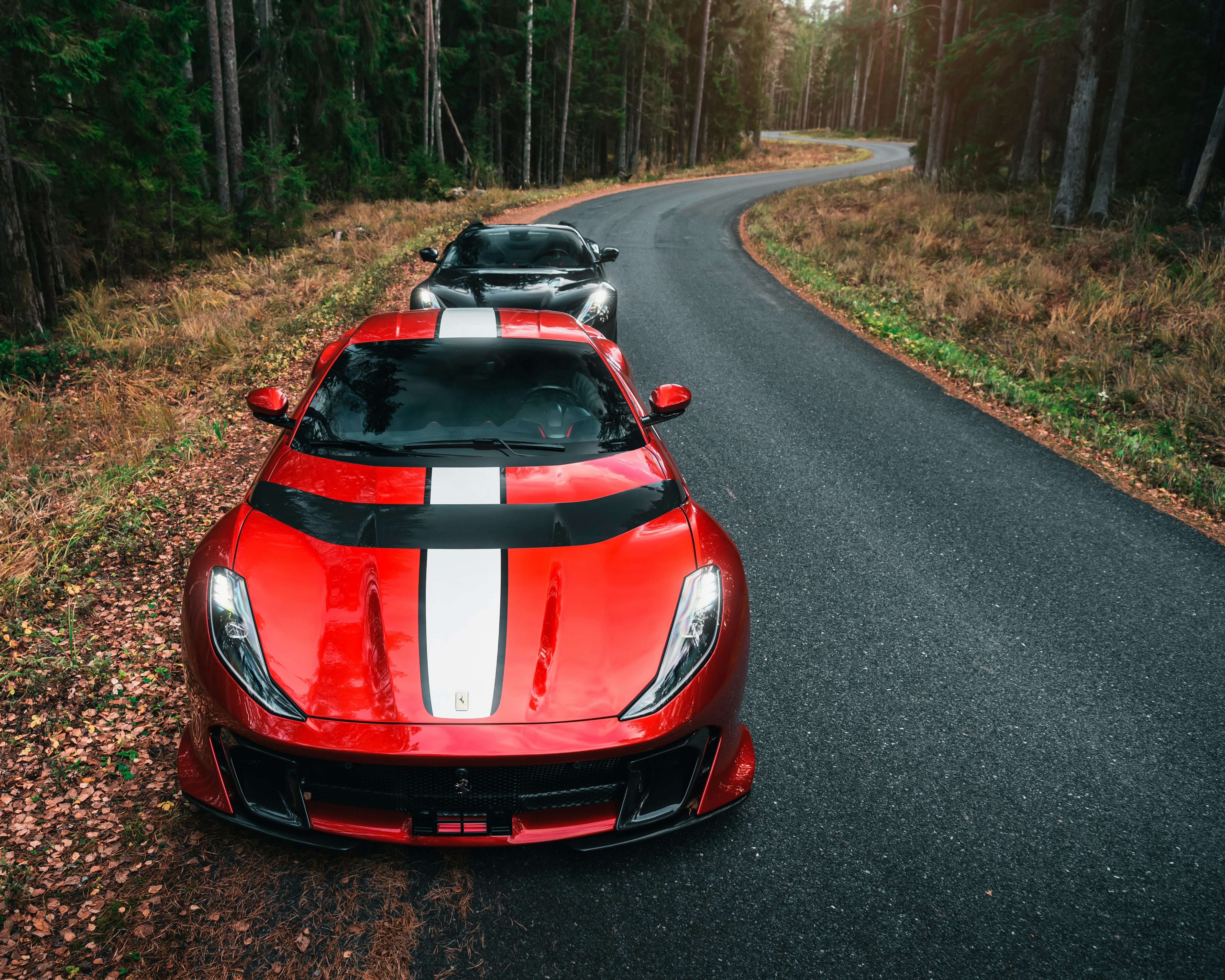 Foto Dos autos deportivos rojos estacionados al costado de una ...