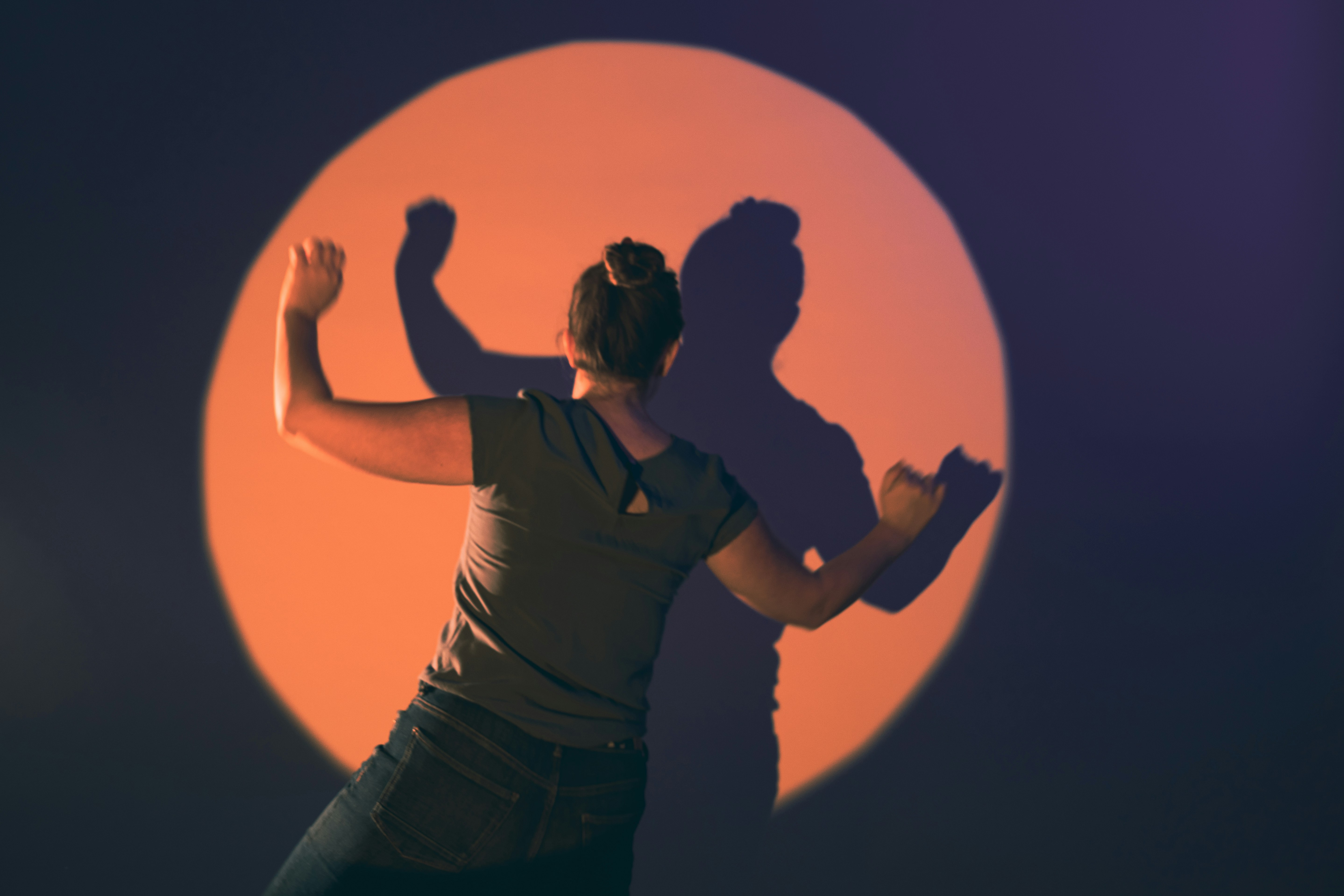 Silhouette in the Orange Ring: A Quiet Dance of Light