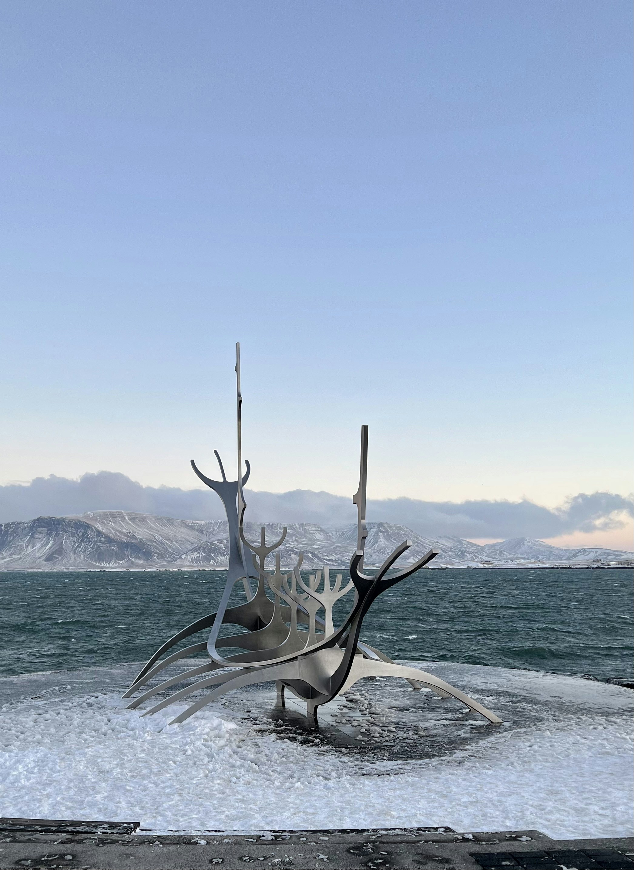 Sun Voyager: Stainless Silhouette on Iceland’s Snow-Scarred Seascape