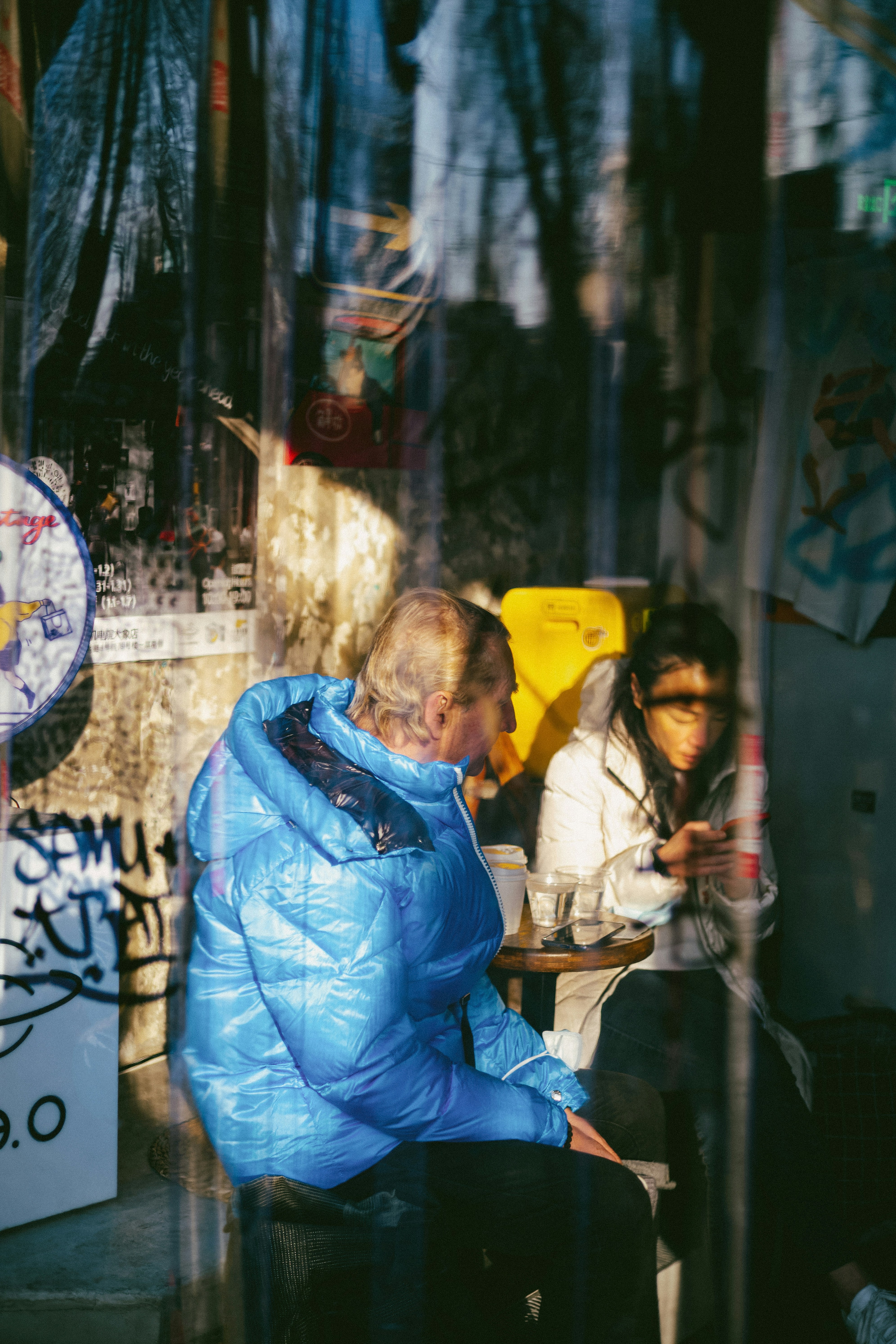 Blue Jacket, Graffiti Café: A Moment Through Glass