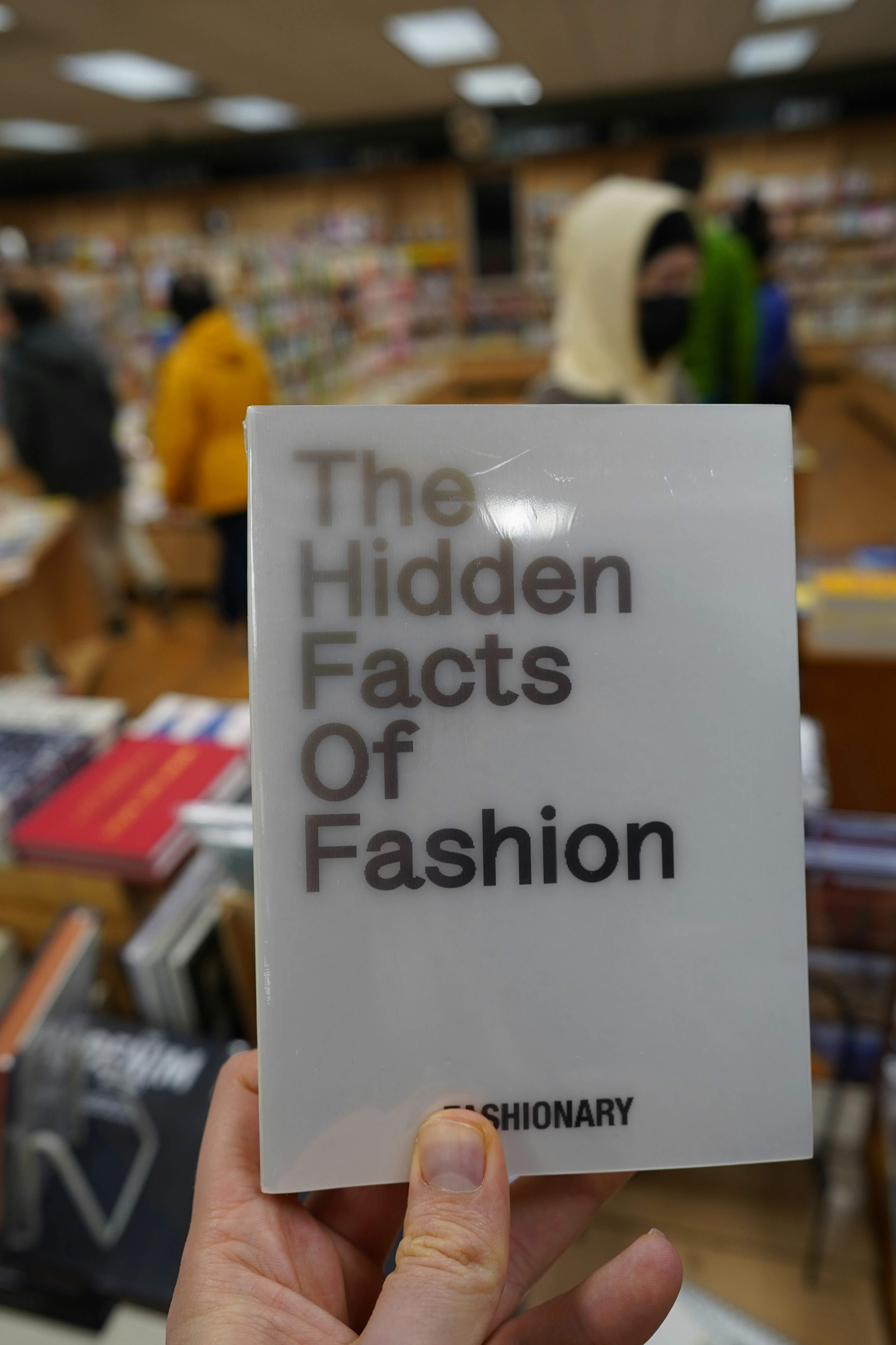 A person holding up a sign in a store photo – Free Usa Image on Unsplash