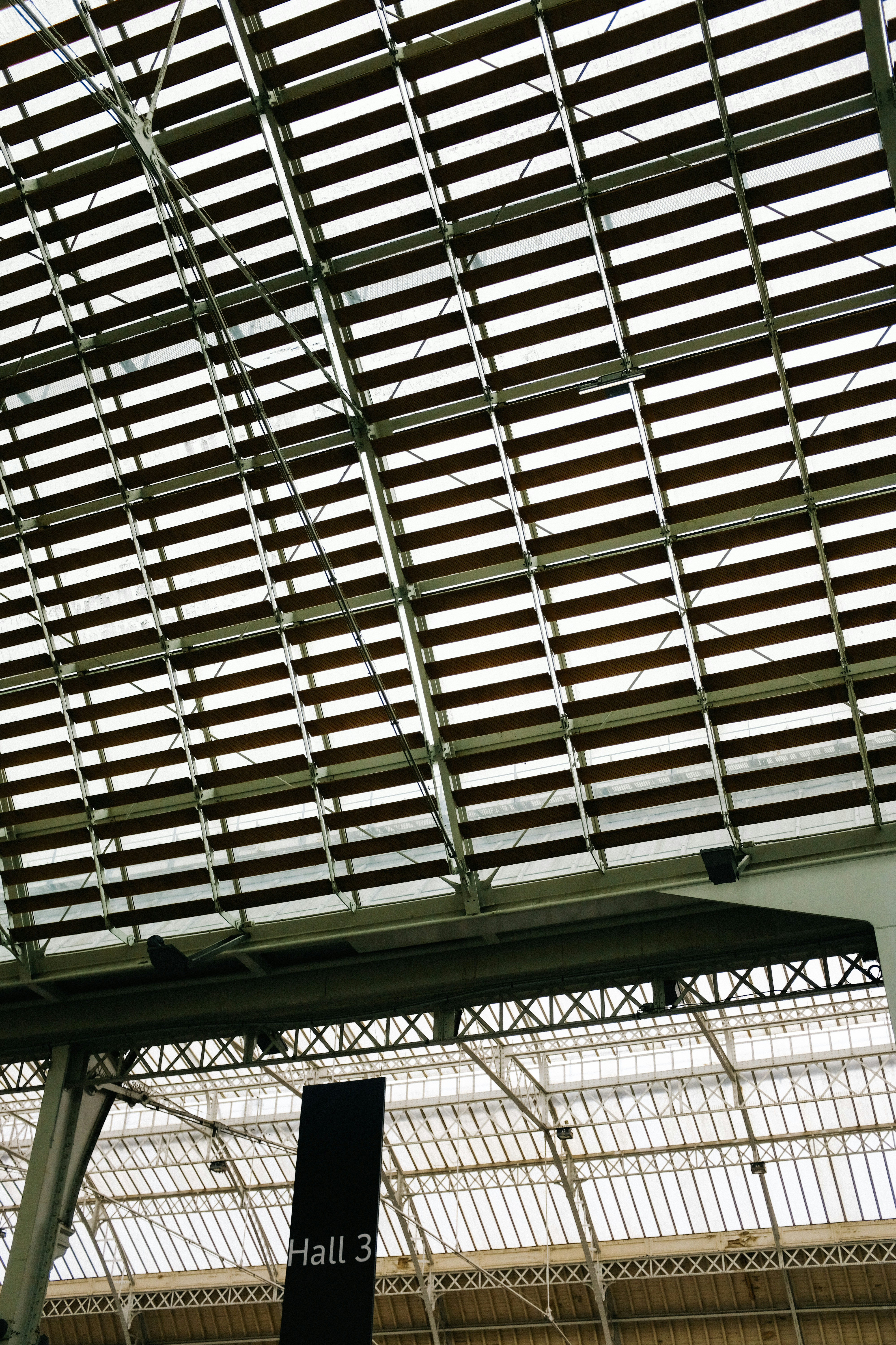 A train station with a large metal roof photo – Free Building Image on ...