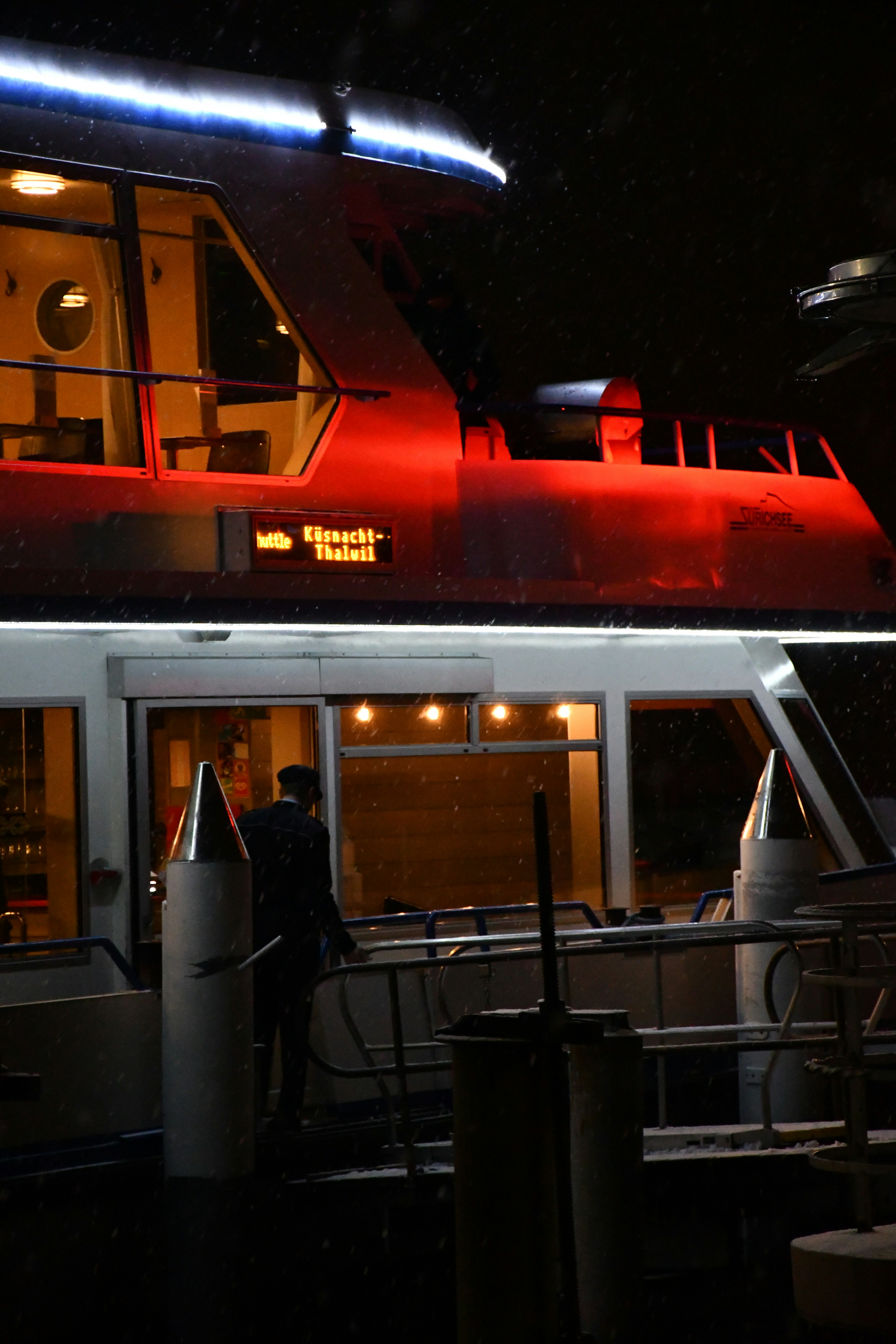 The passenger ferry across the Lake of Zurich while it snows.