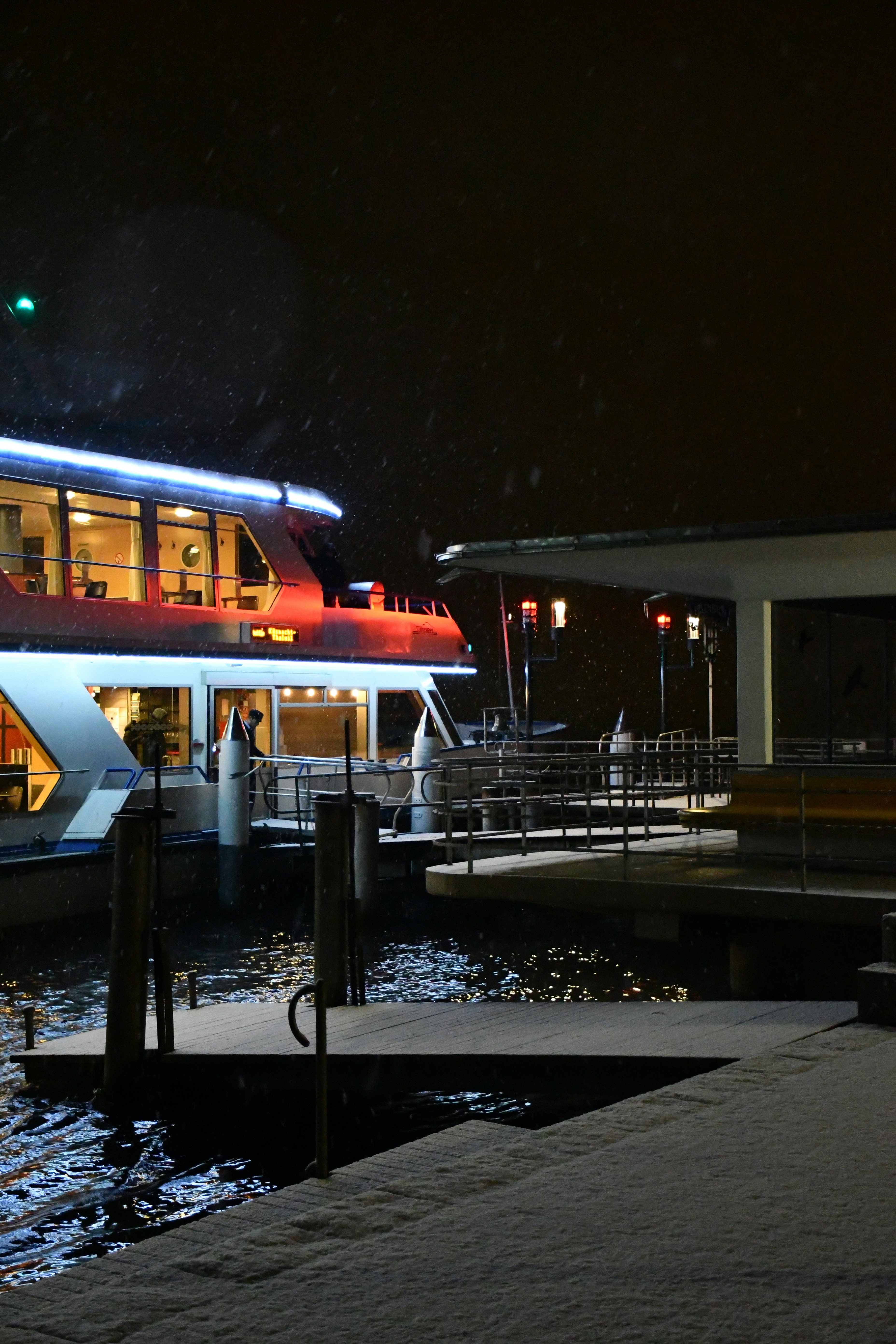 Neon-Lit Ferry at a Snow-Dusted Harbor