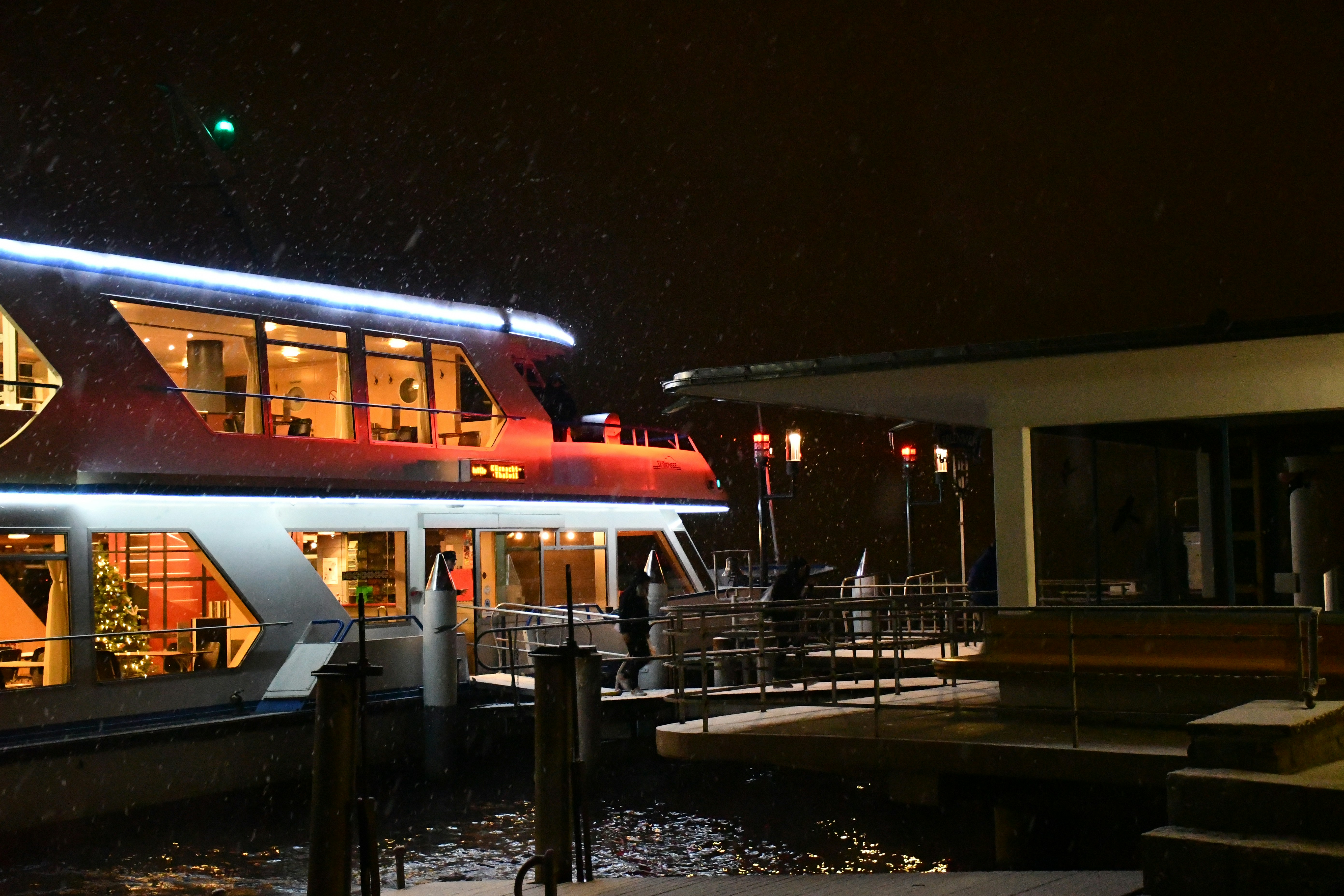 The passenger ferry across the Lake of Zurich while it snows.
