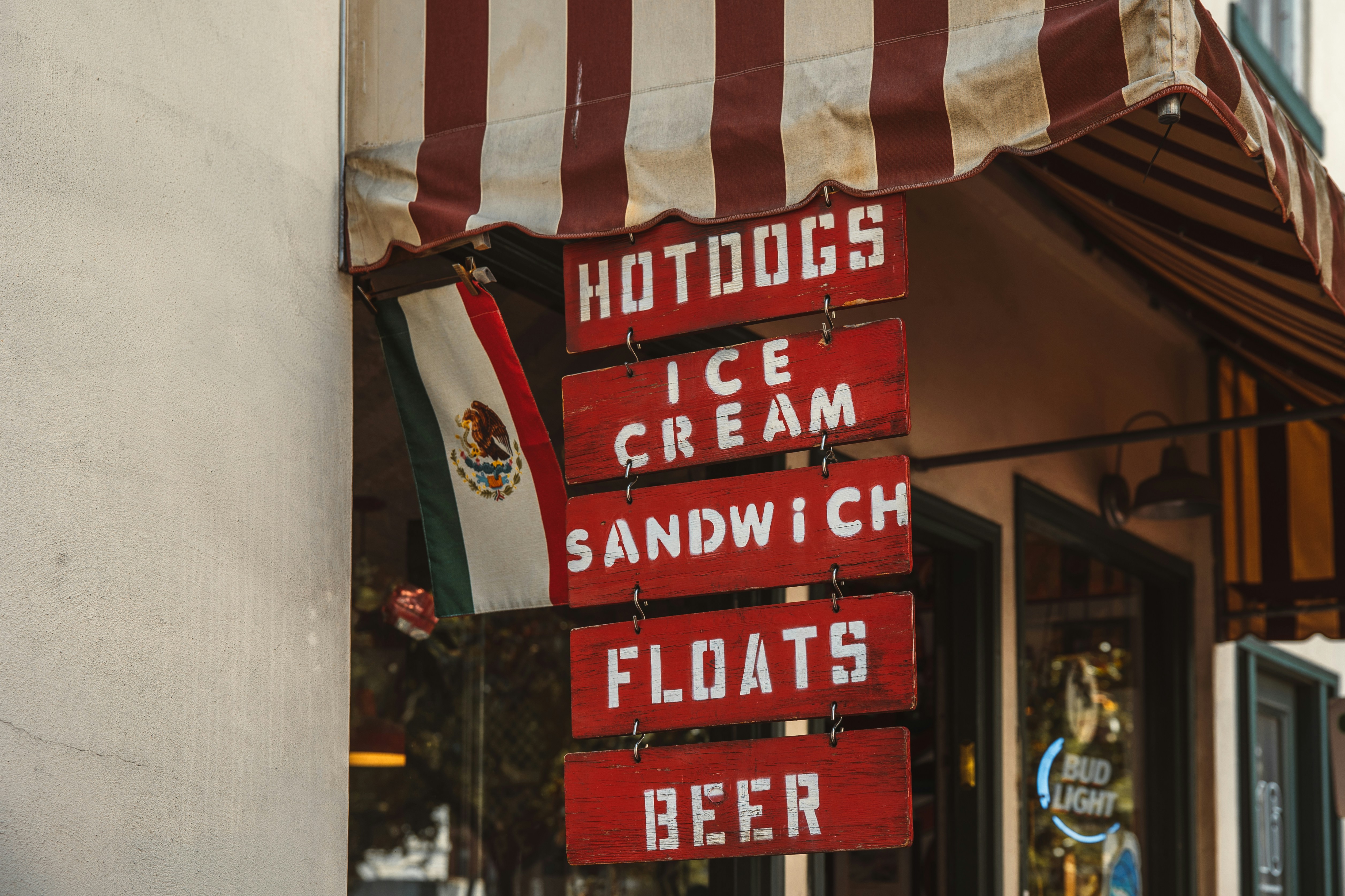Vertical Menu Signs Under a Candy-Stripe Awning