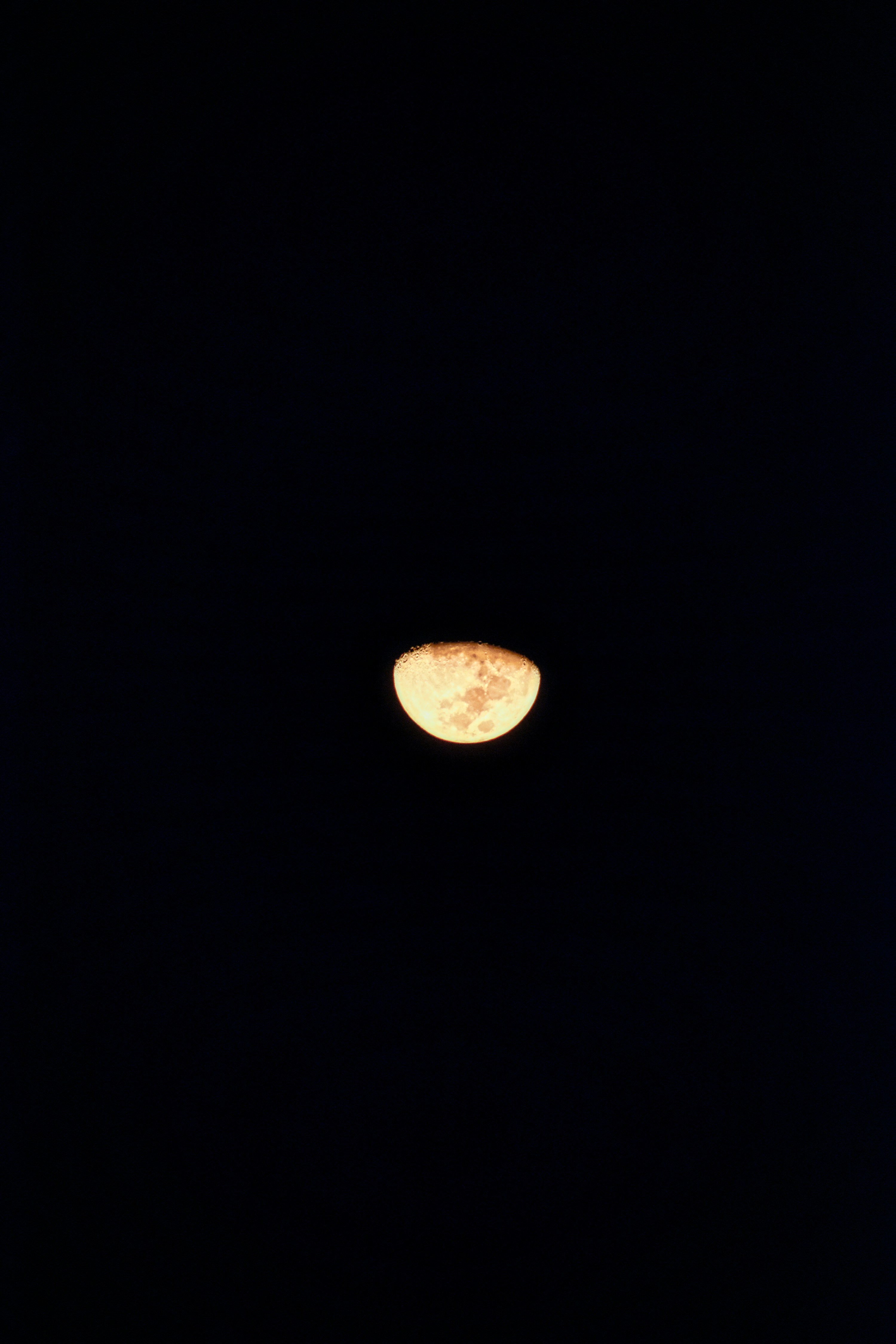 Cratered Lantern: A Gibbous Moon in Velvet Night