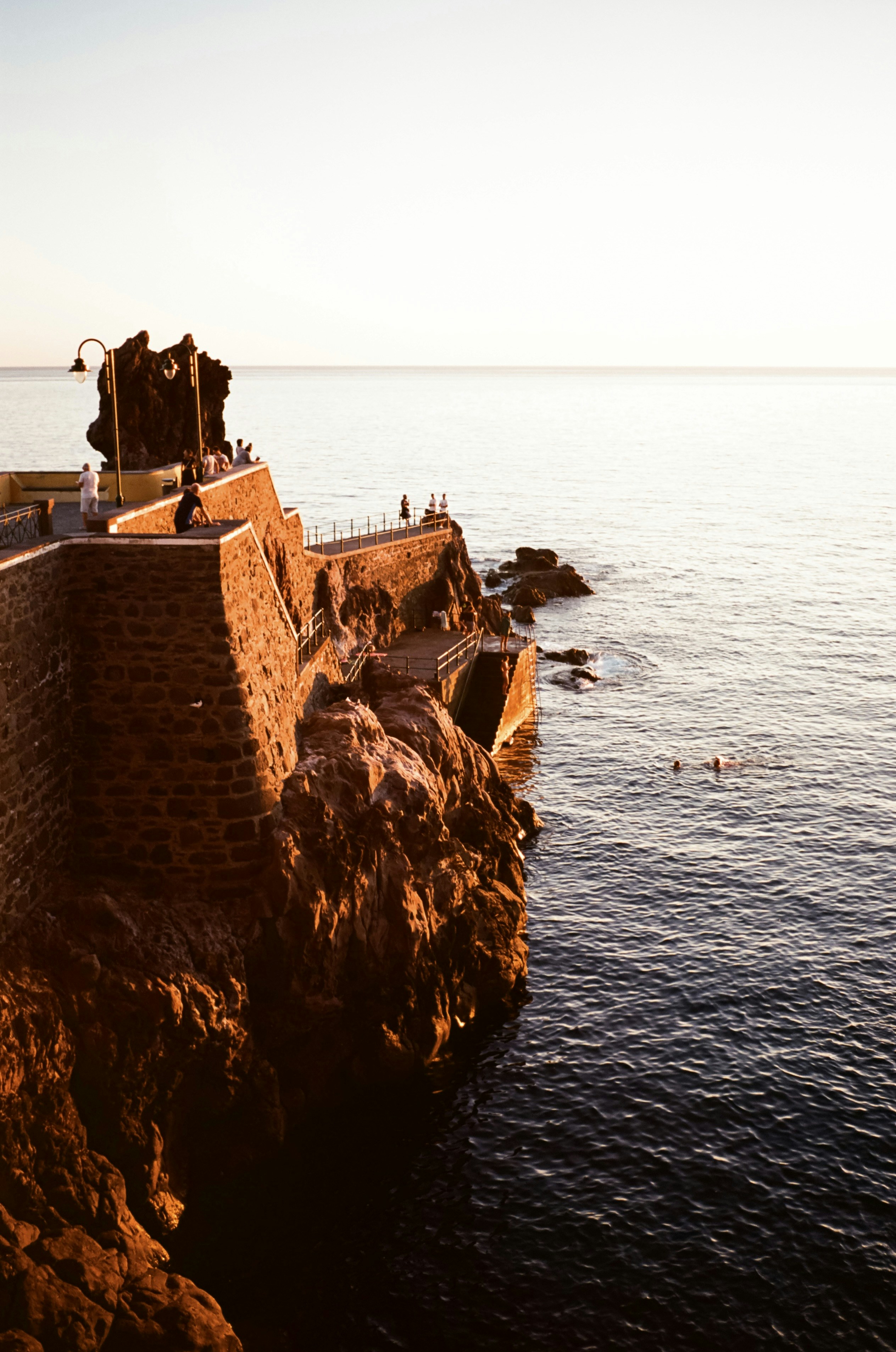 Sunlit Promenade Cliffs: Evening at the Coastal Fortress