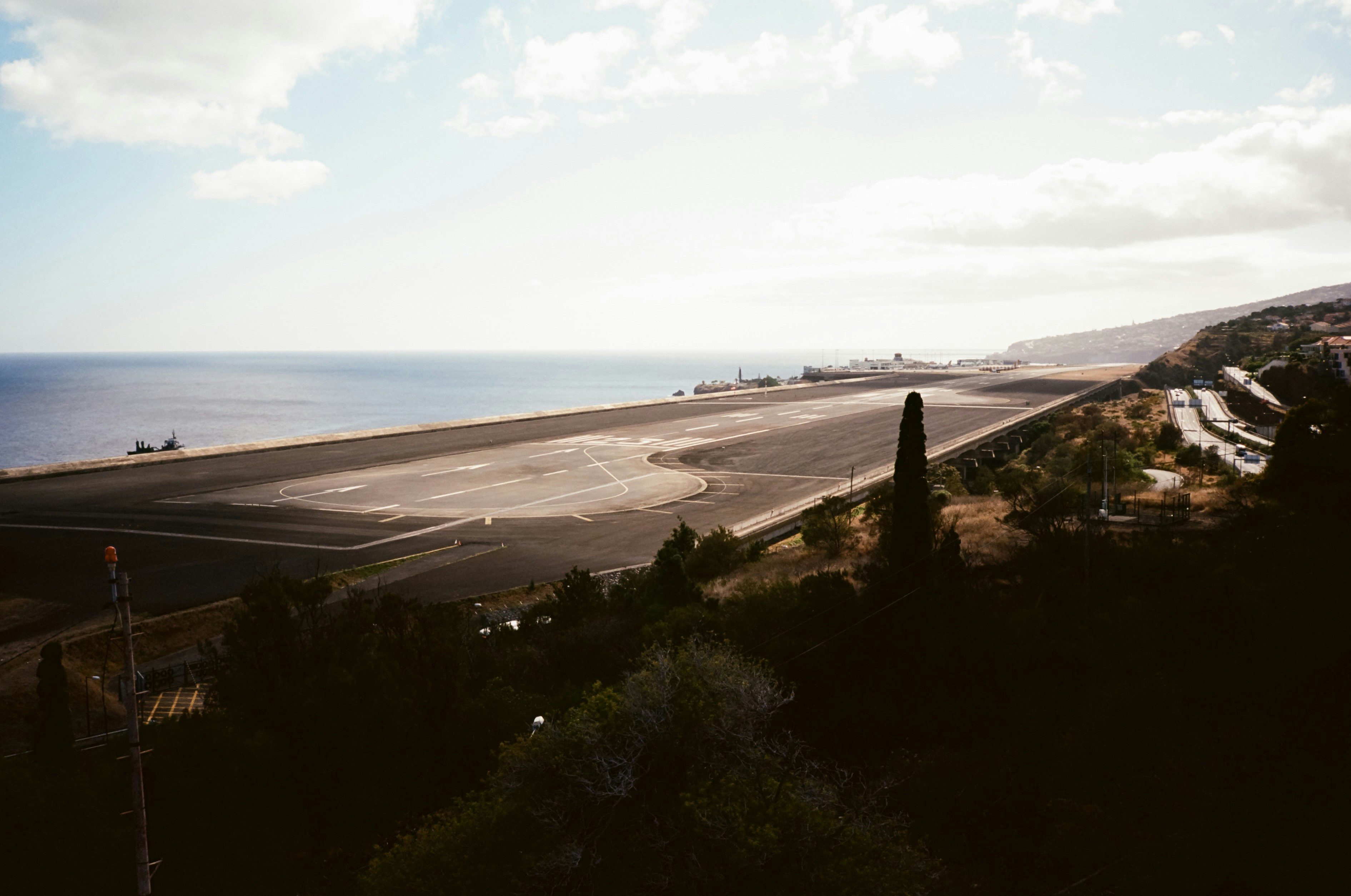 Coastal Runway at Dusk: Quiet Prominence Over the Shaded Hills