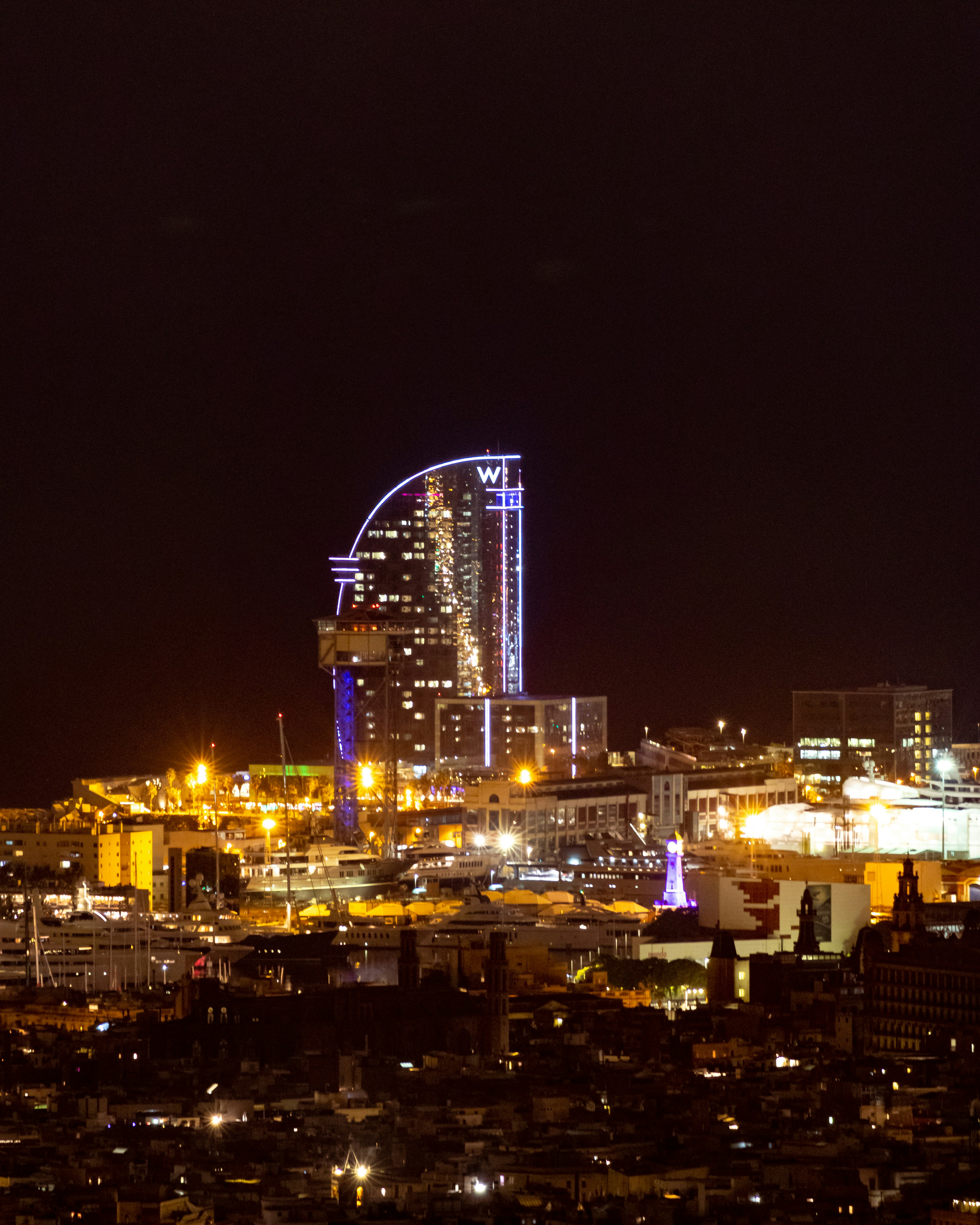 Neon Crescent Over the Harbor Skyline