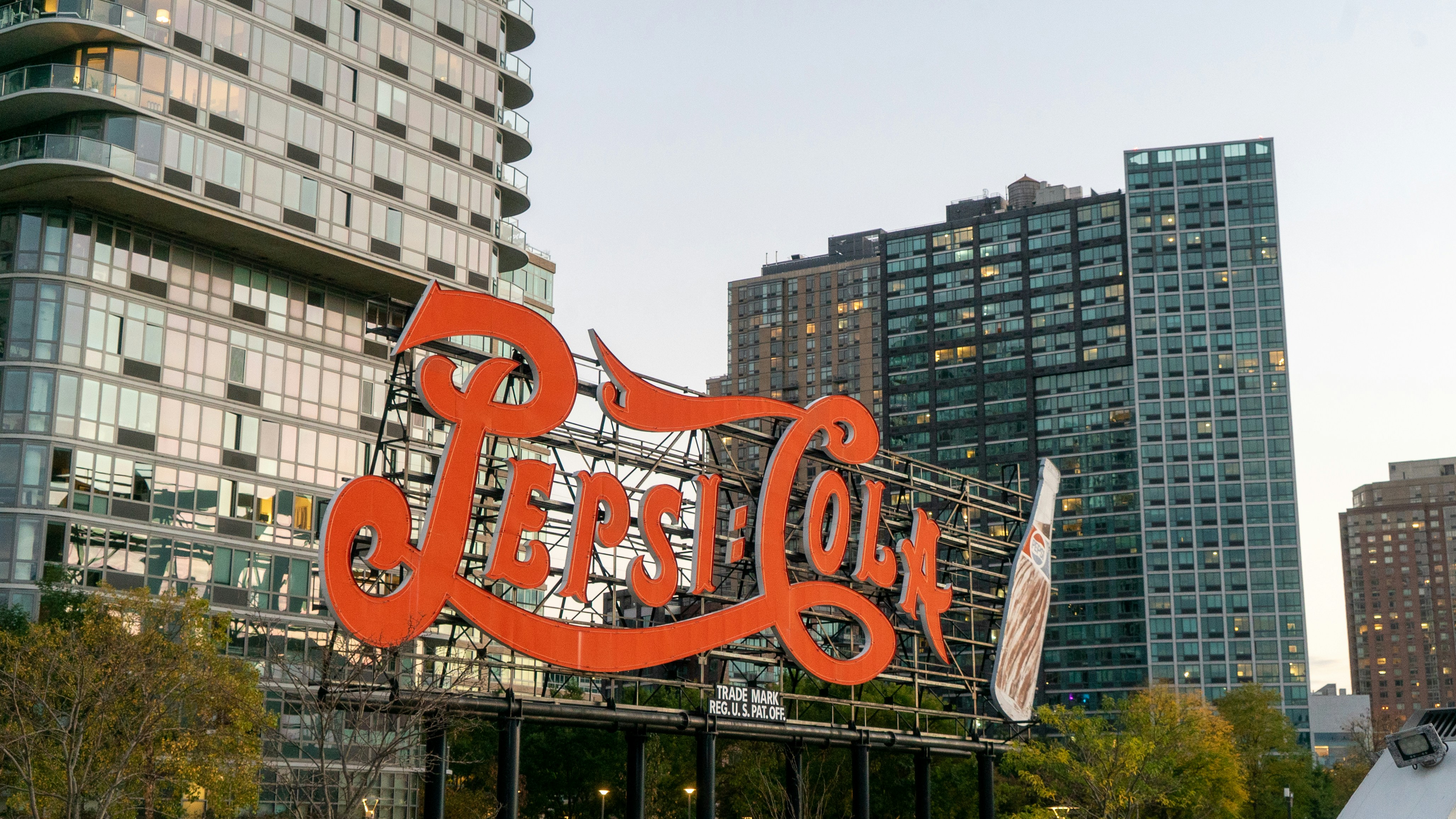 A large coca cola sign on top of a building photo – Free Ny Image on ...