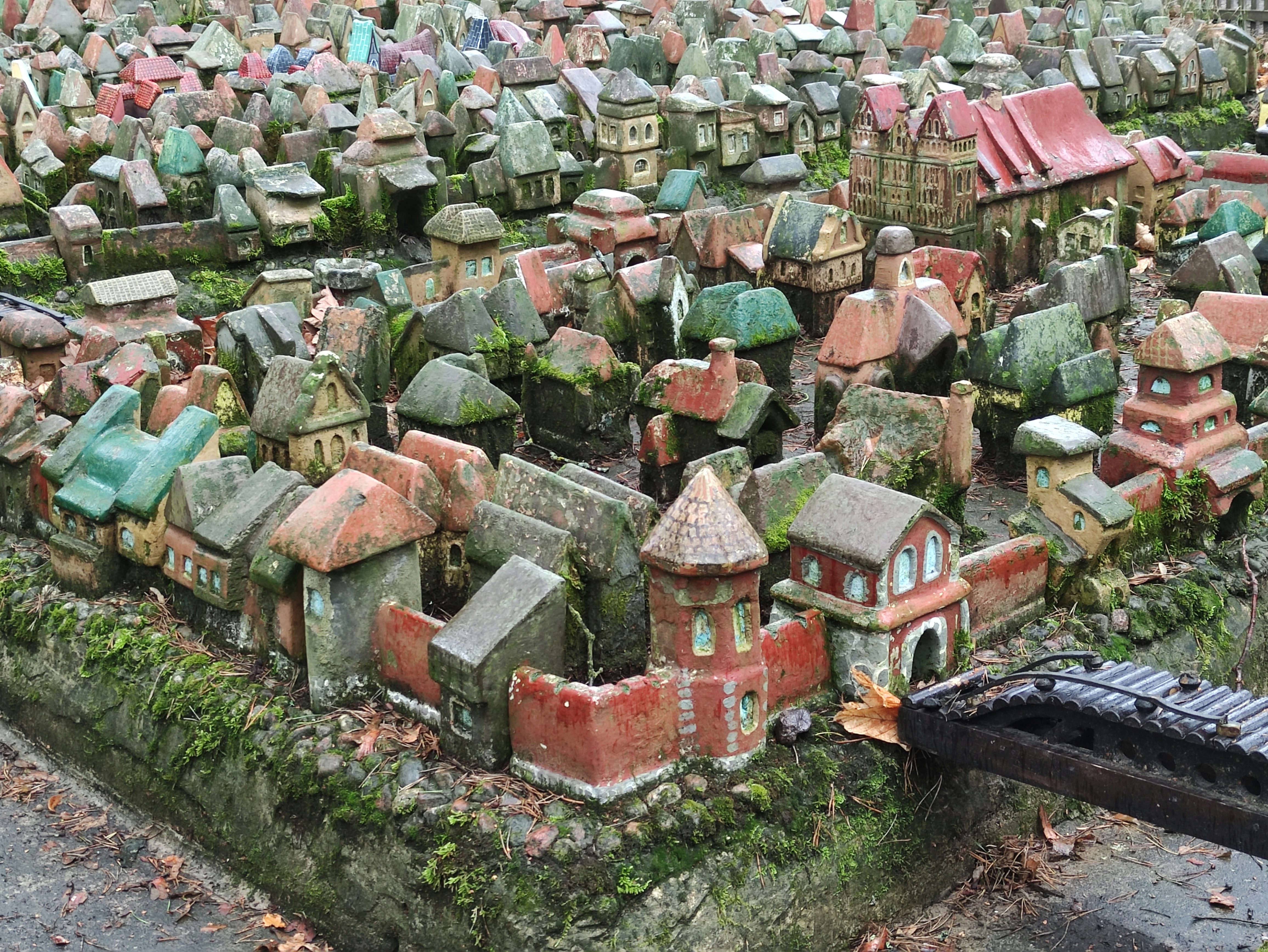 Patchwork Village: A Mossy Hill of Colorful Ceramic Houses
