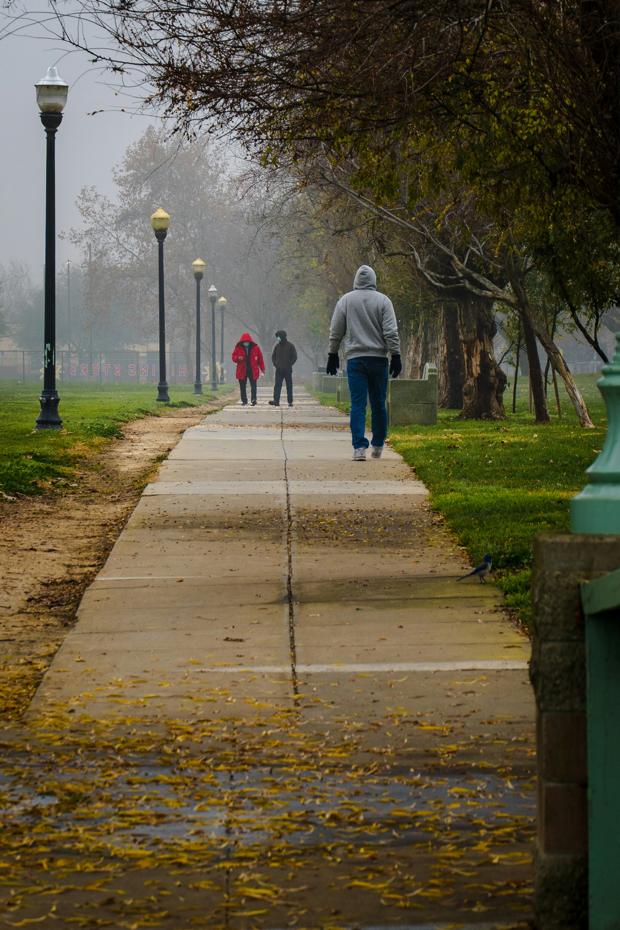 a group of people walking down a sidewalk
