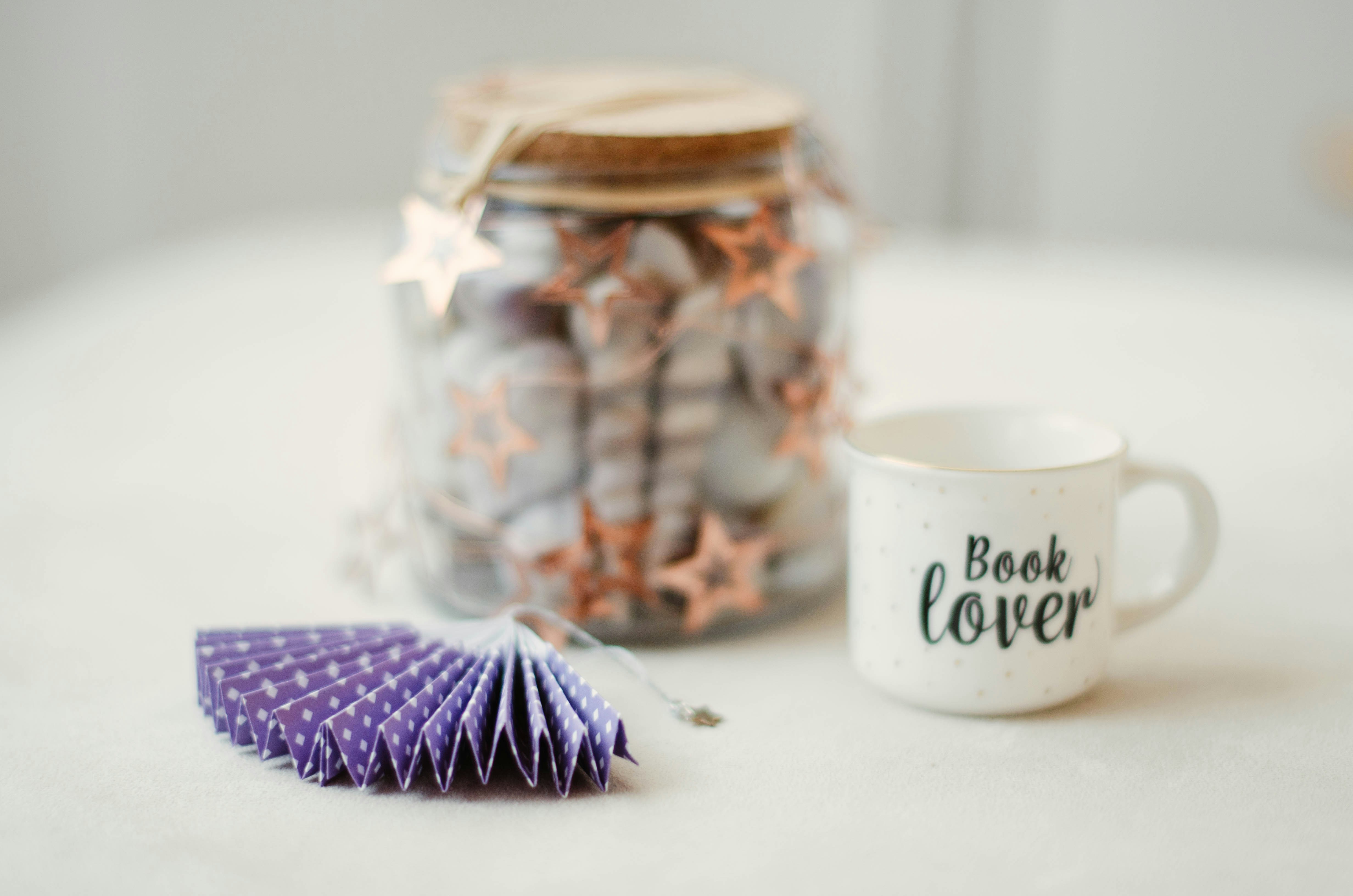 Soft Geometry on White: Purple Origami Star with a Jar of Stars and a Book Lover Mug