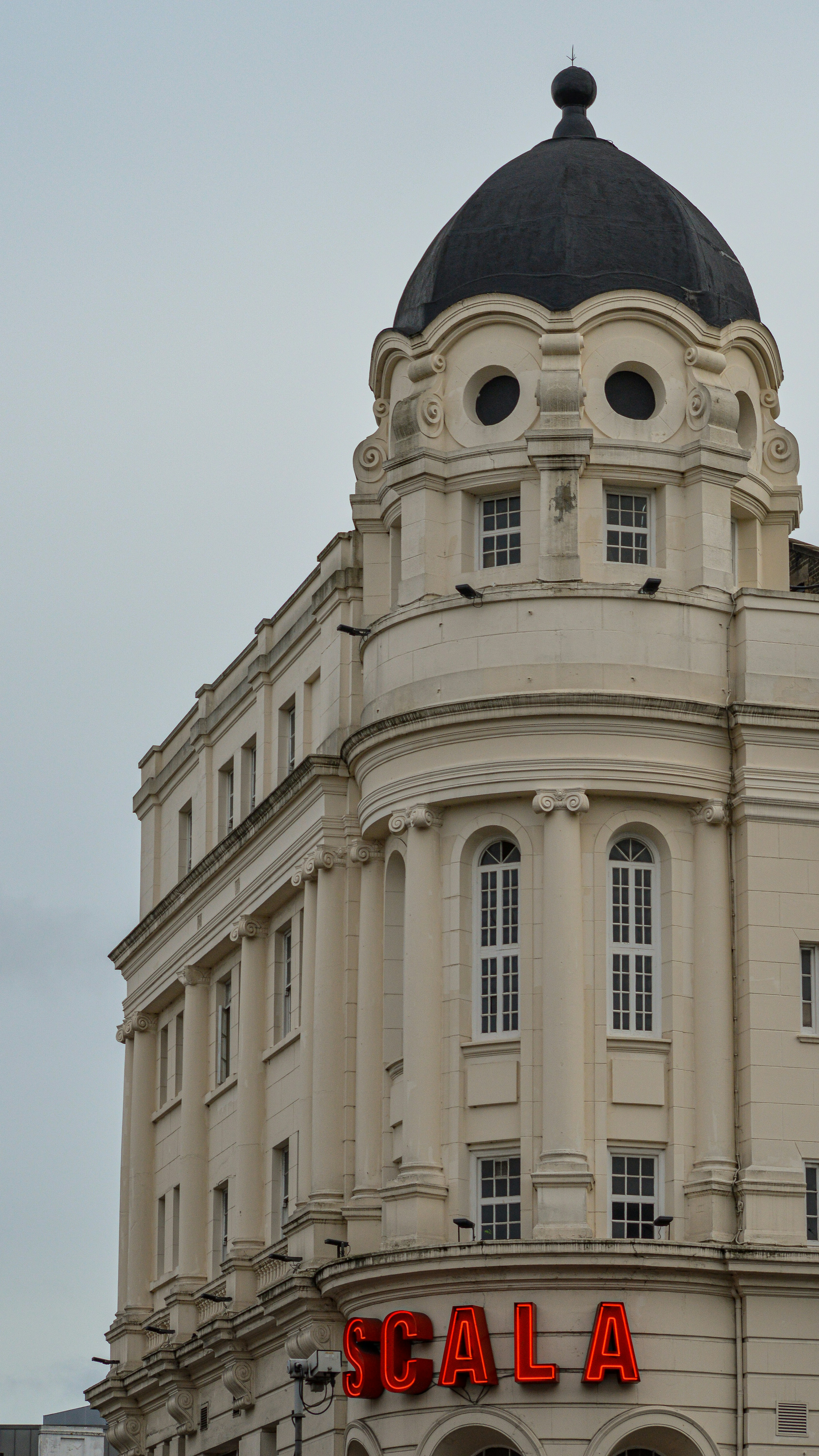 a large white building with a black dome on top