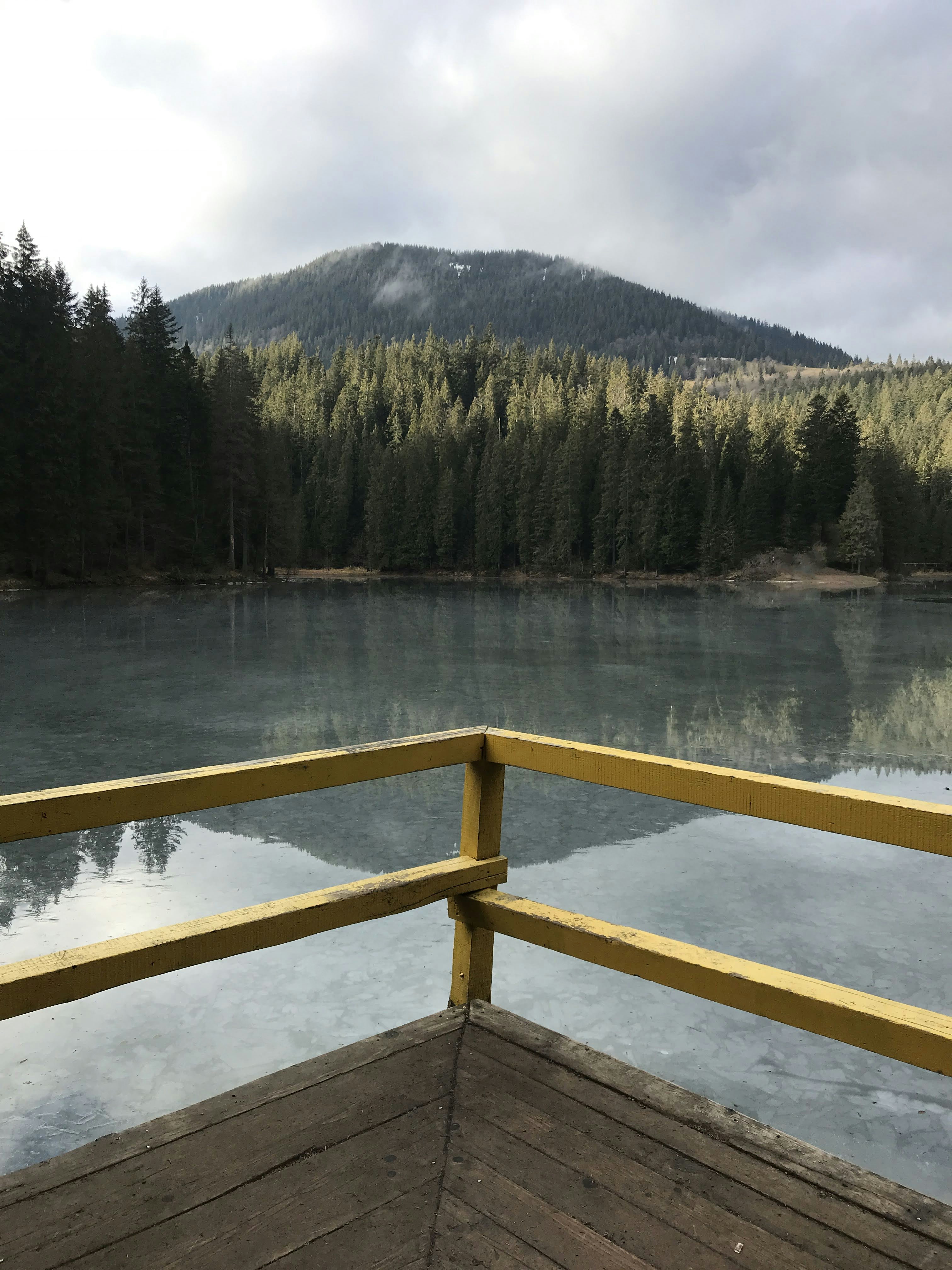 Yellow Railings Overlooking a Silent Mountain Lake
