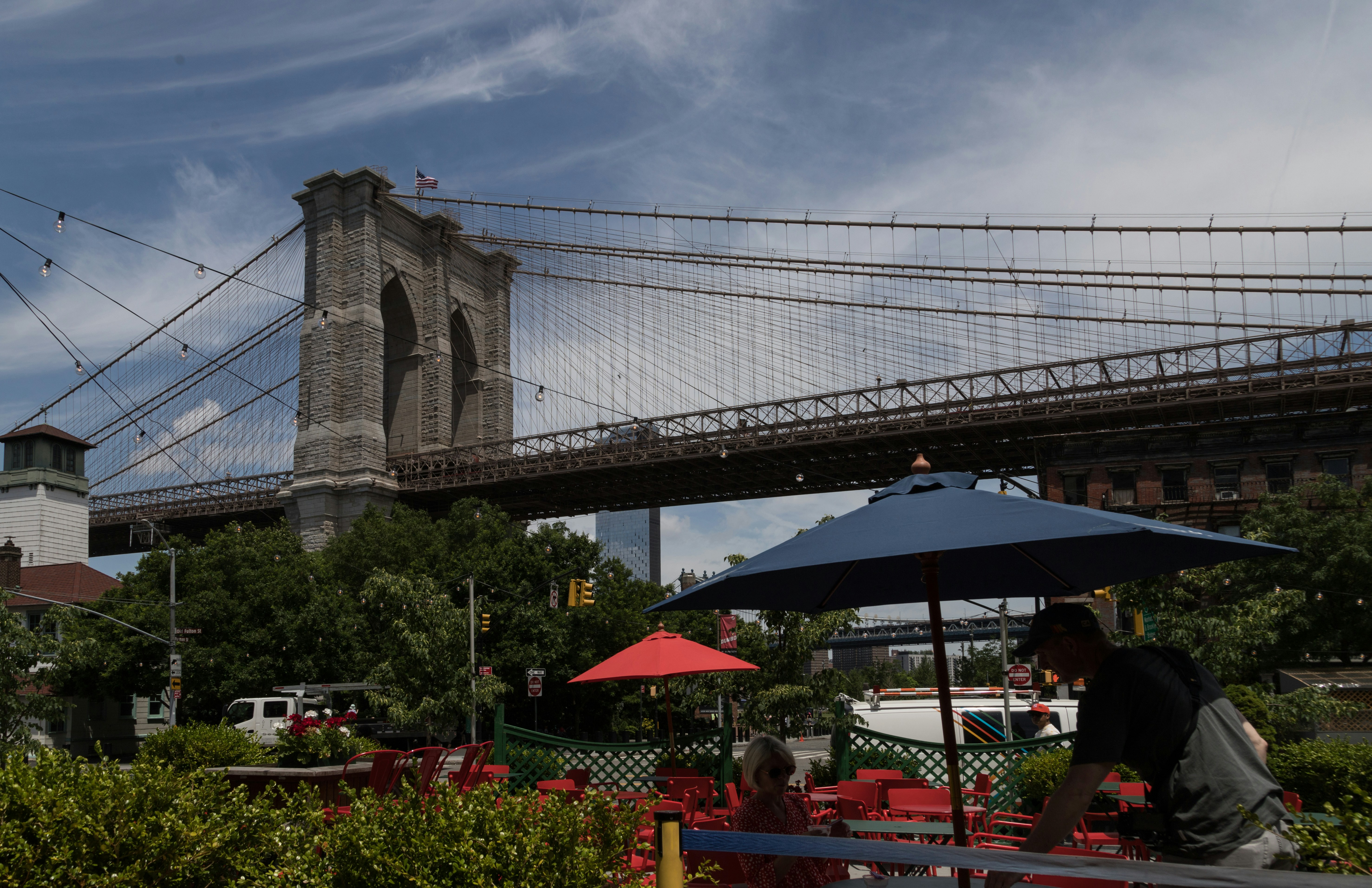 Riverside Café under the Arched Span of a City Bridge