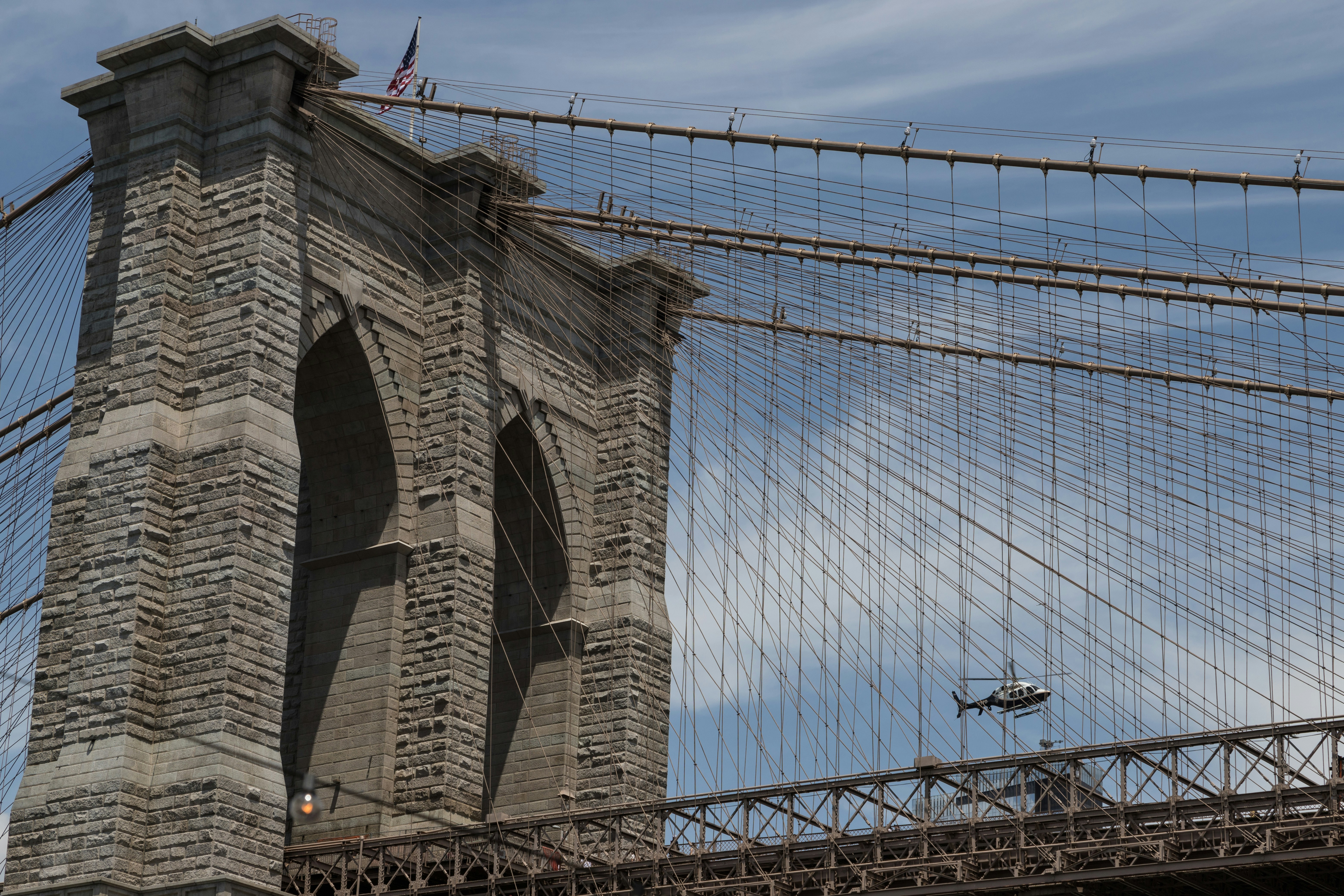 Stone Gatekeeper: Brooklyn Bridge tower carved by a lattice of steel cables