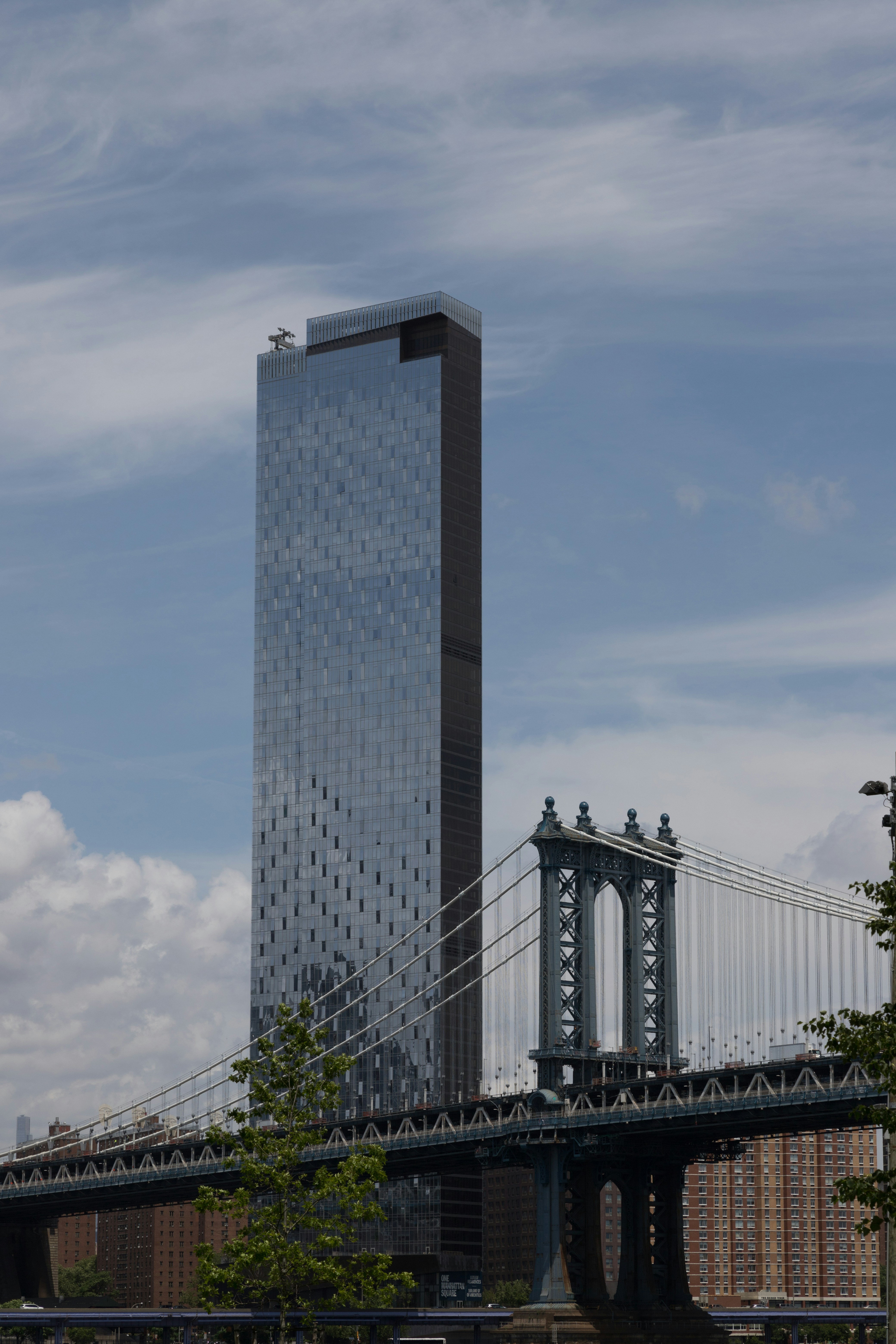 A tall building sitting next to a bridge photo – Free Fulton ferry ...