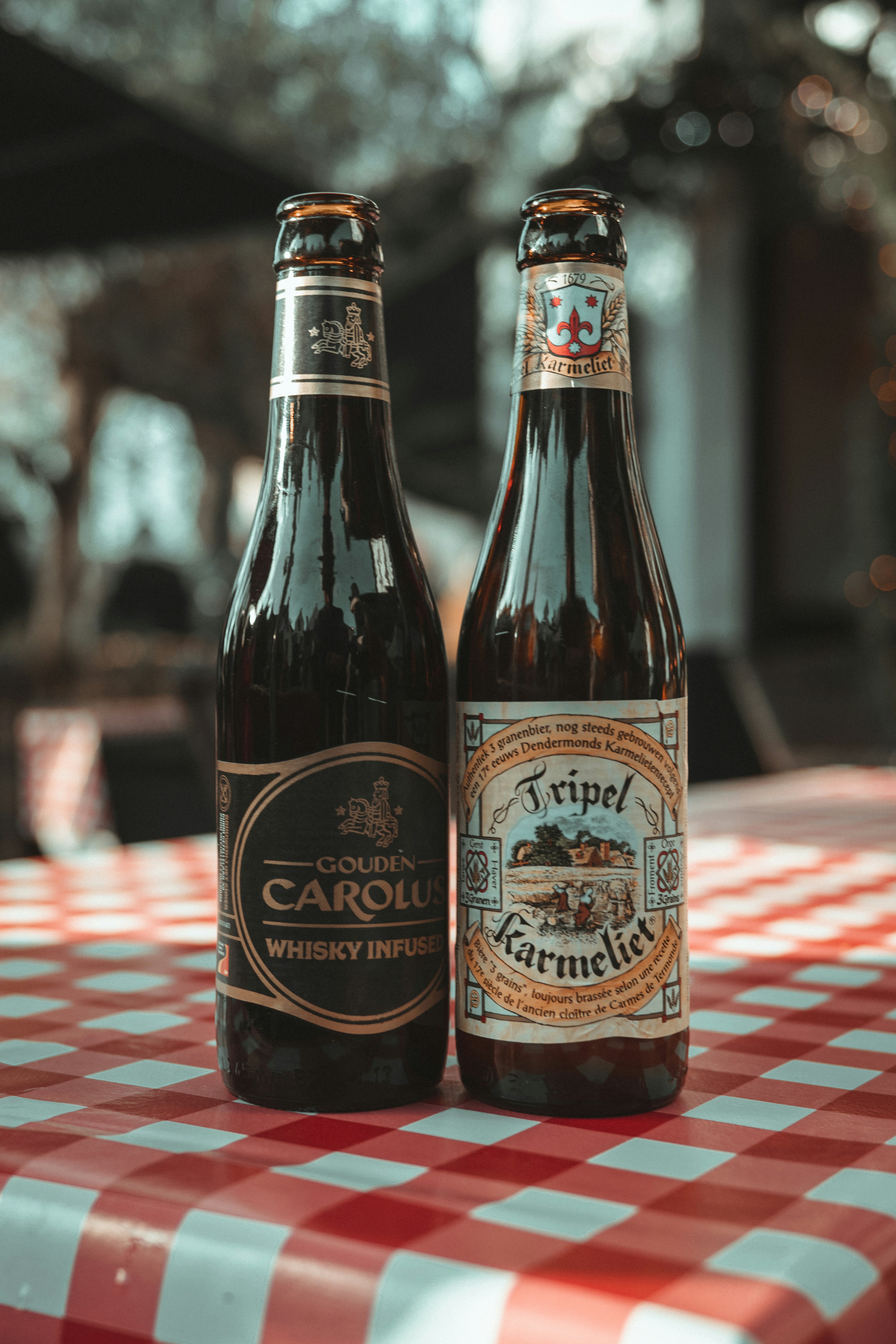 two bottles of beer sitting on top of a table
