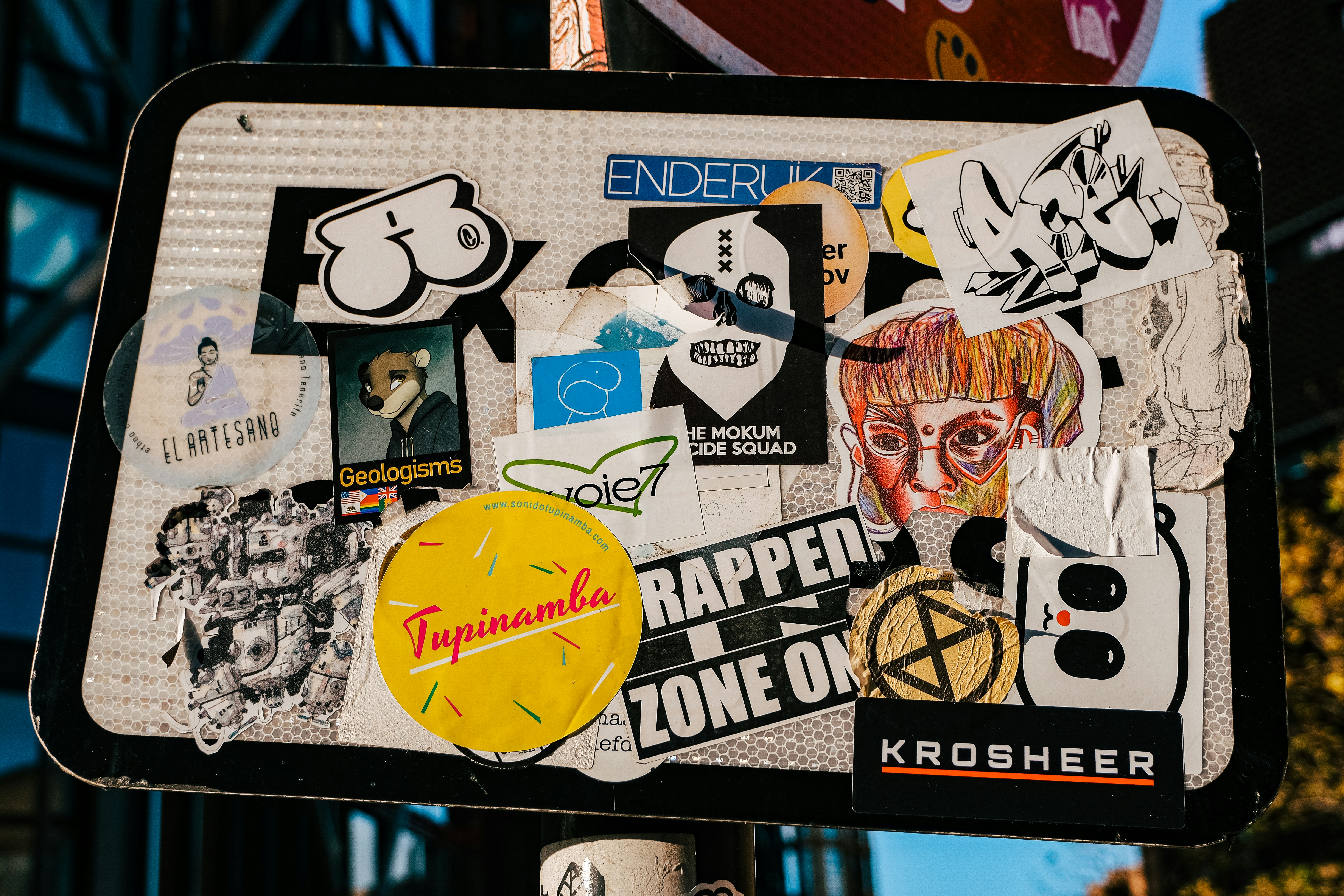 A close up of a street sign with many stickers on it photo – Free ...