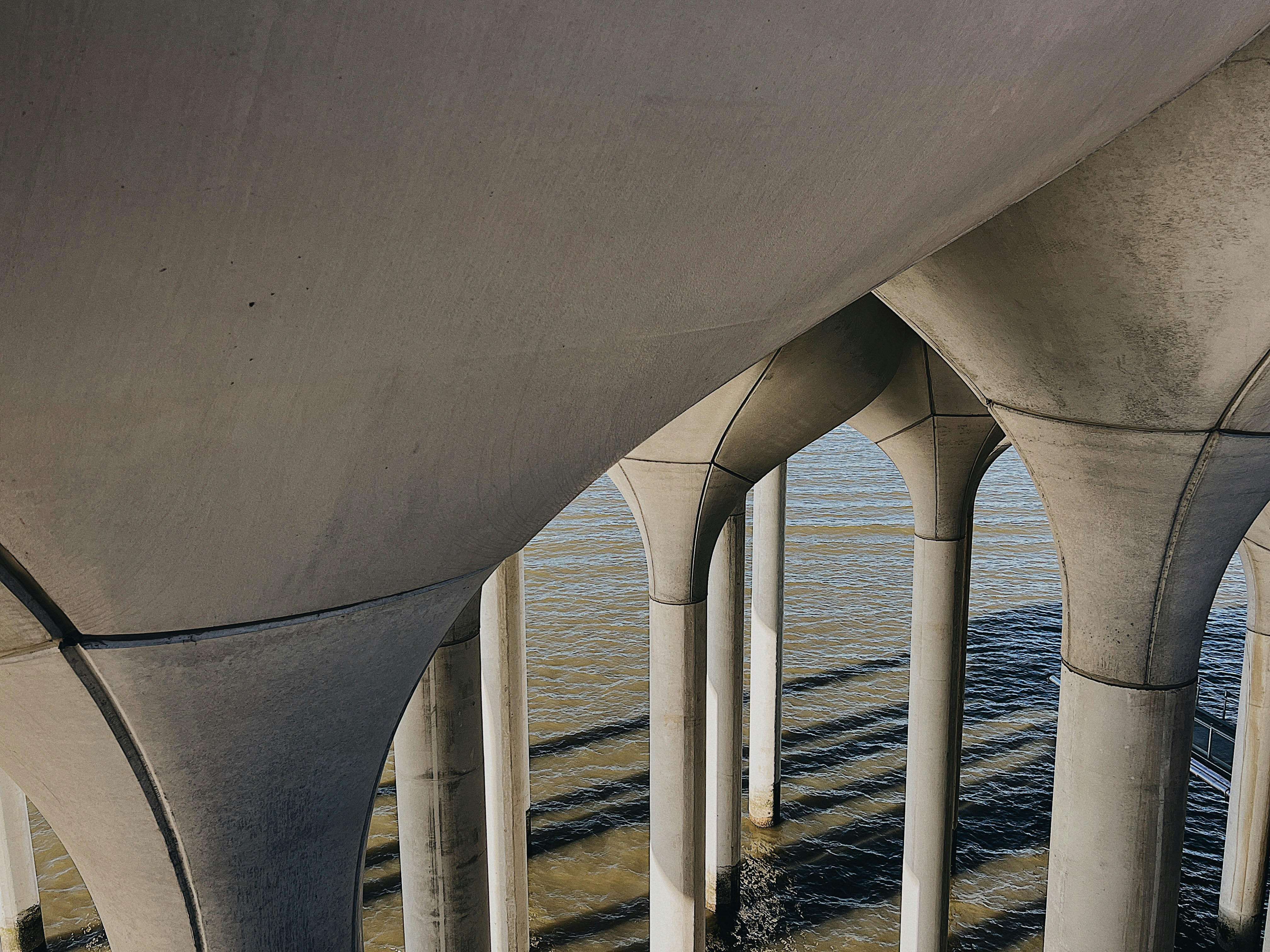 Echoes of Concrete: Archway Rhythm Along the Waterfront