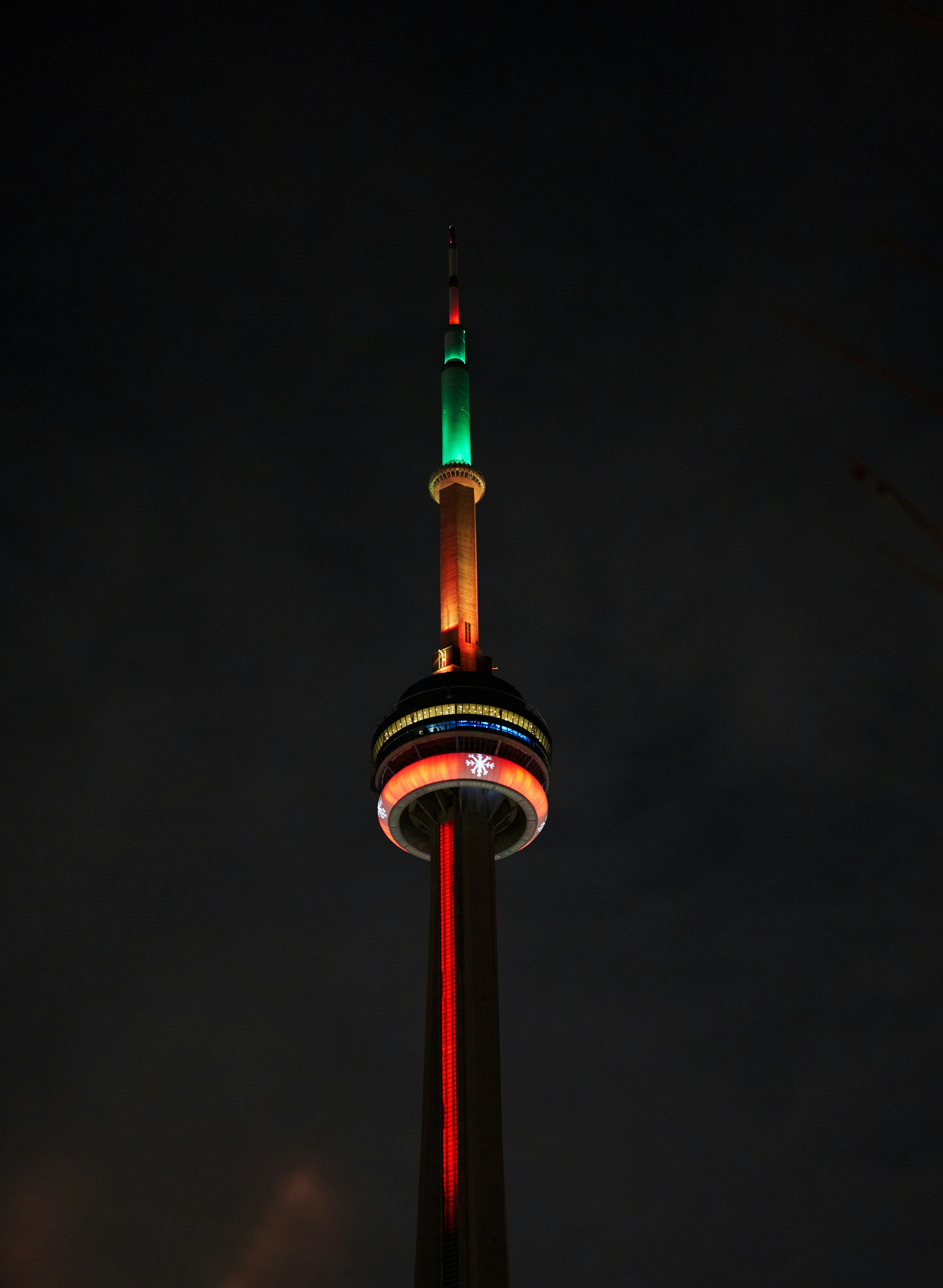 A very tall tower with a very colorful light on it's side photo – Free ...