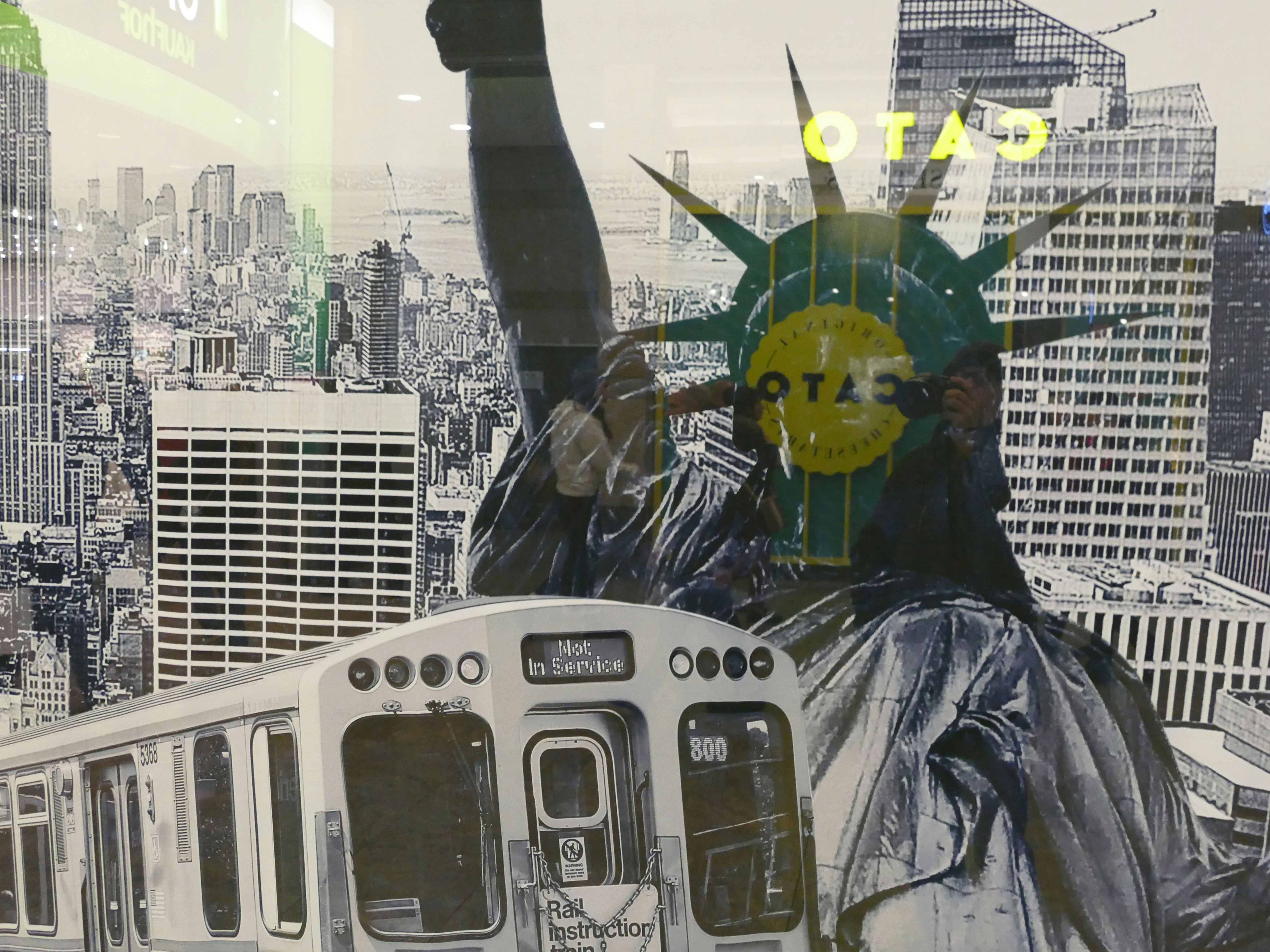Artistic collage featuring the Statue of Liberty with a subway train against a city skyline.
